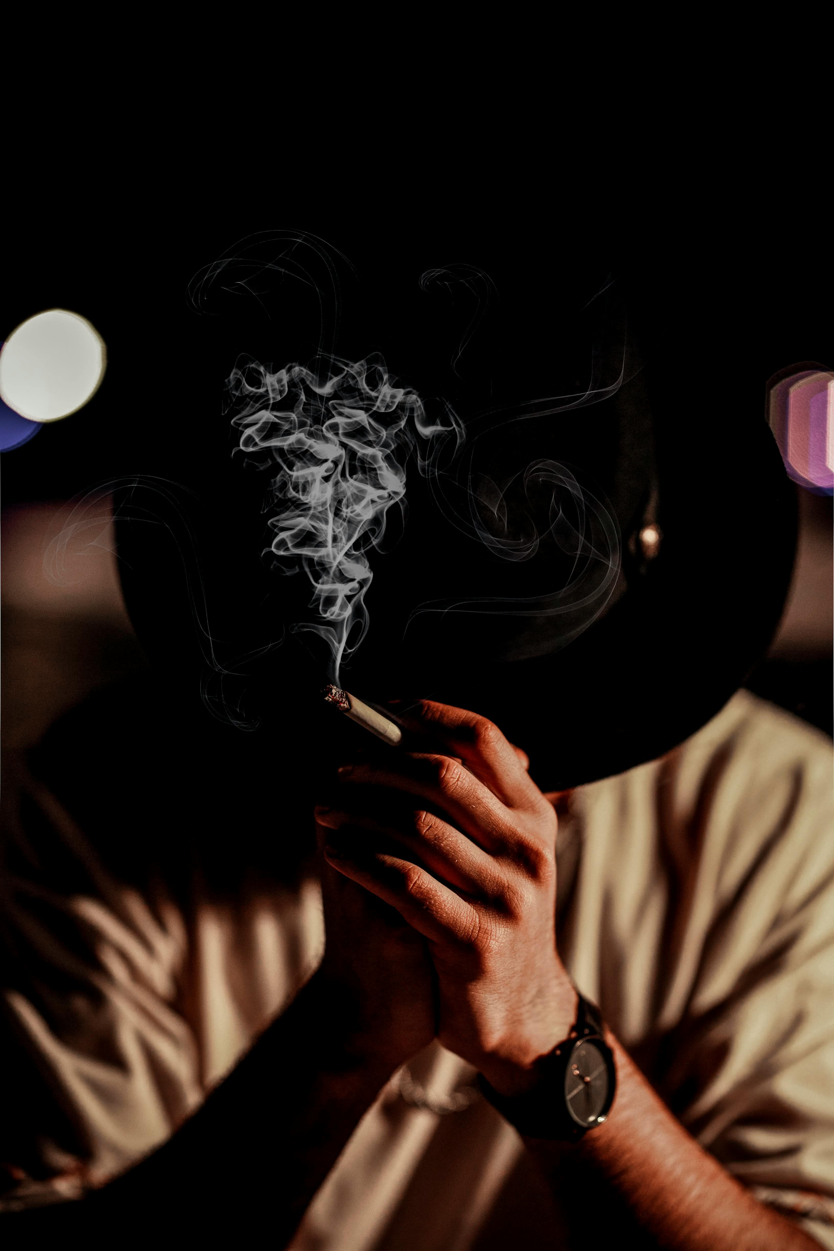 Person Wearing Black Fedora Hat Smoking Cigarette · Free Stock Photo