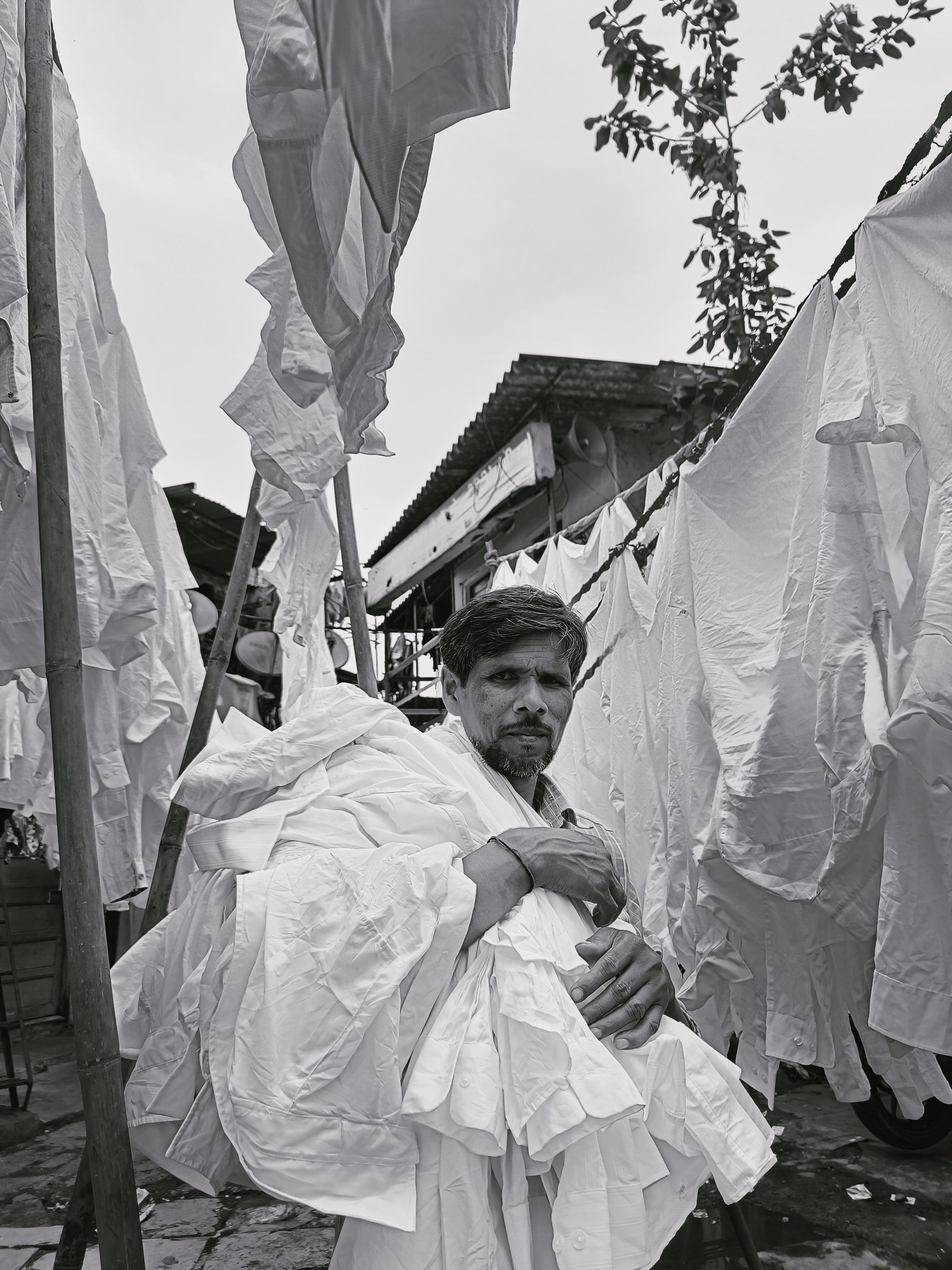 Grayscale Photo of a Man Carrying a Pile of White Clothes · Free Stock ...