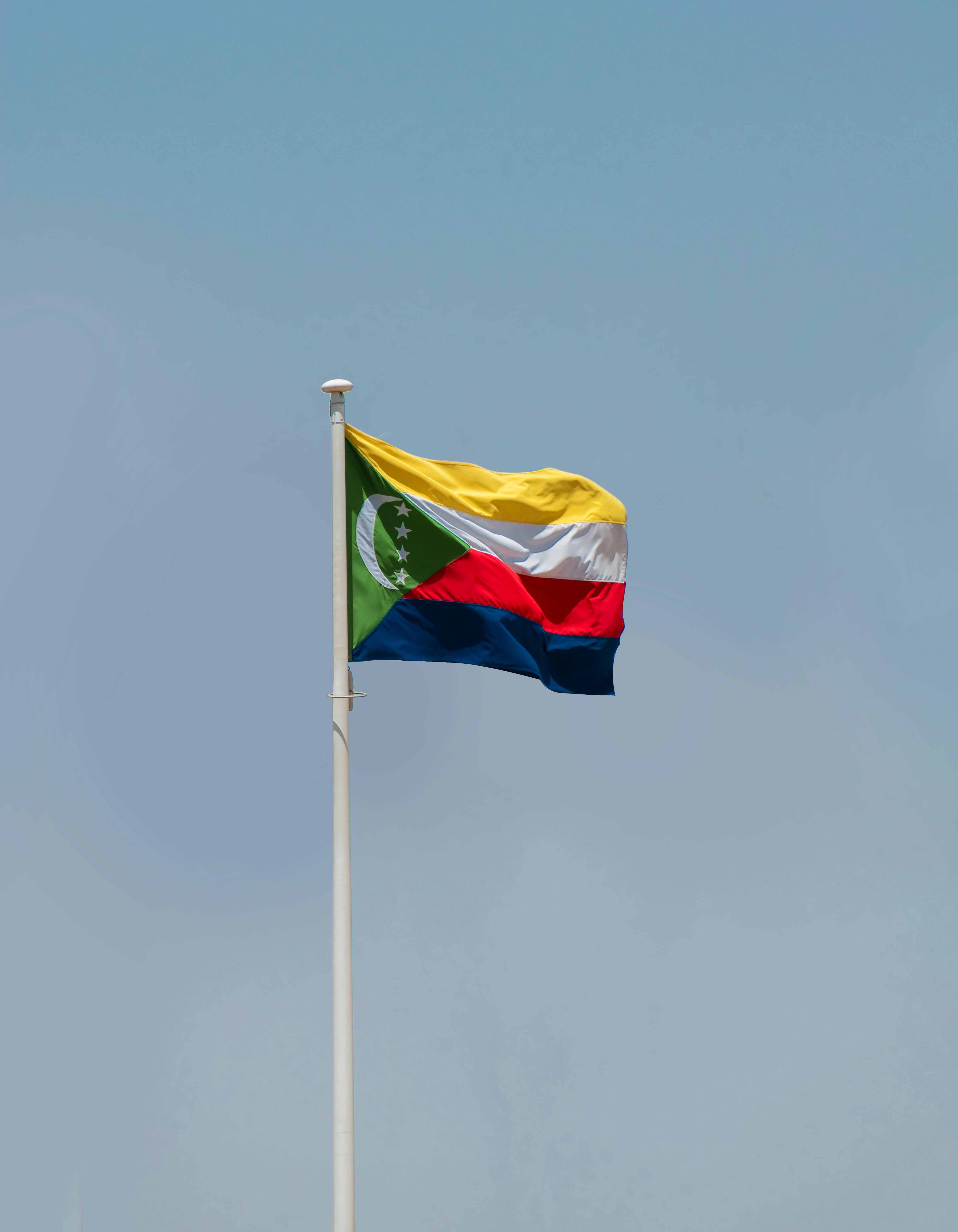 Flags of Different Countries on White Flagpoles · Free Stock Photo