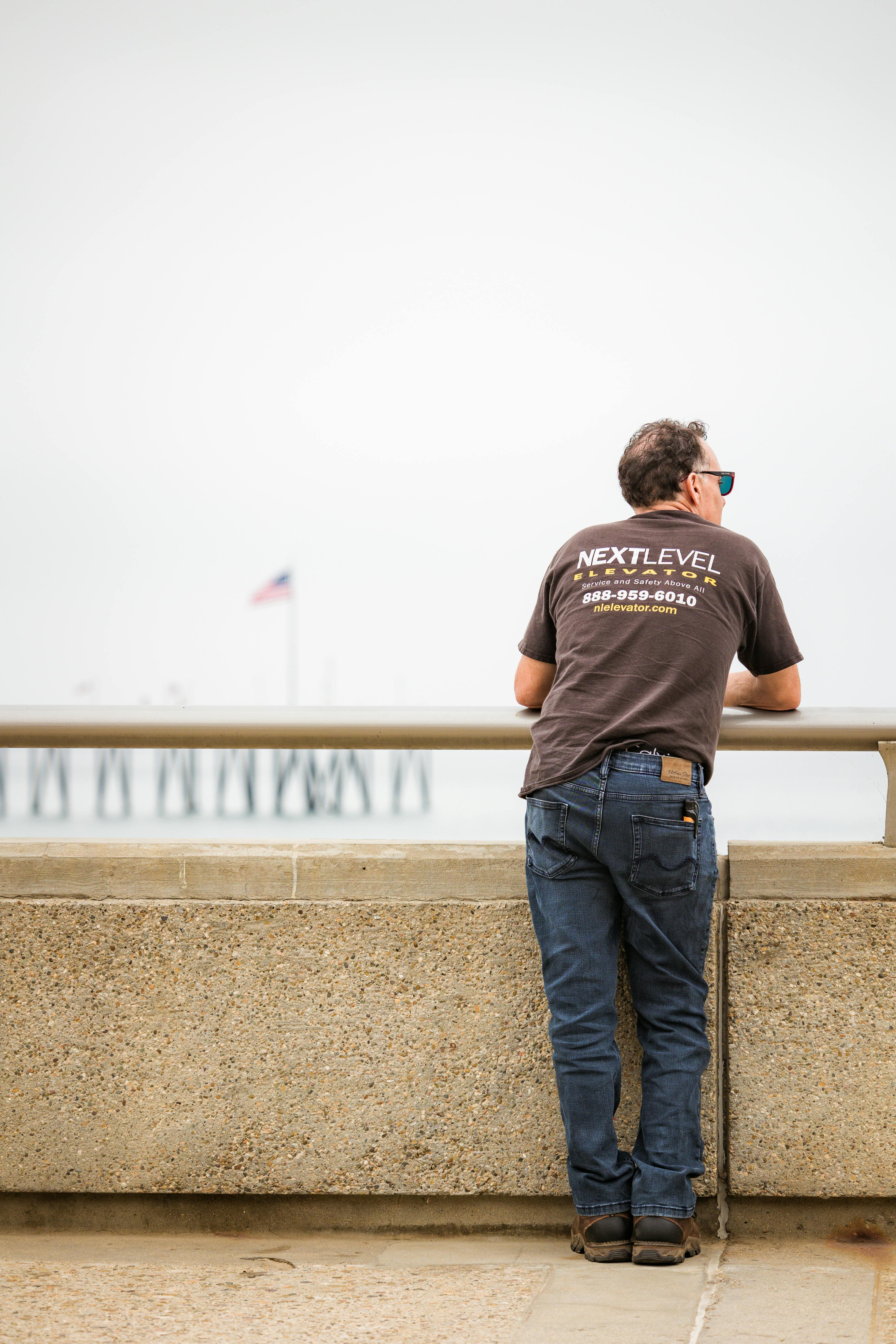 Man Standing Beside Railing · Free Stock Photo