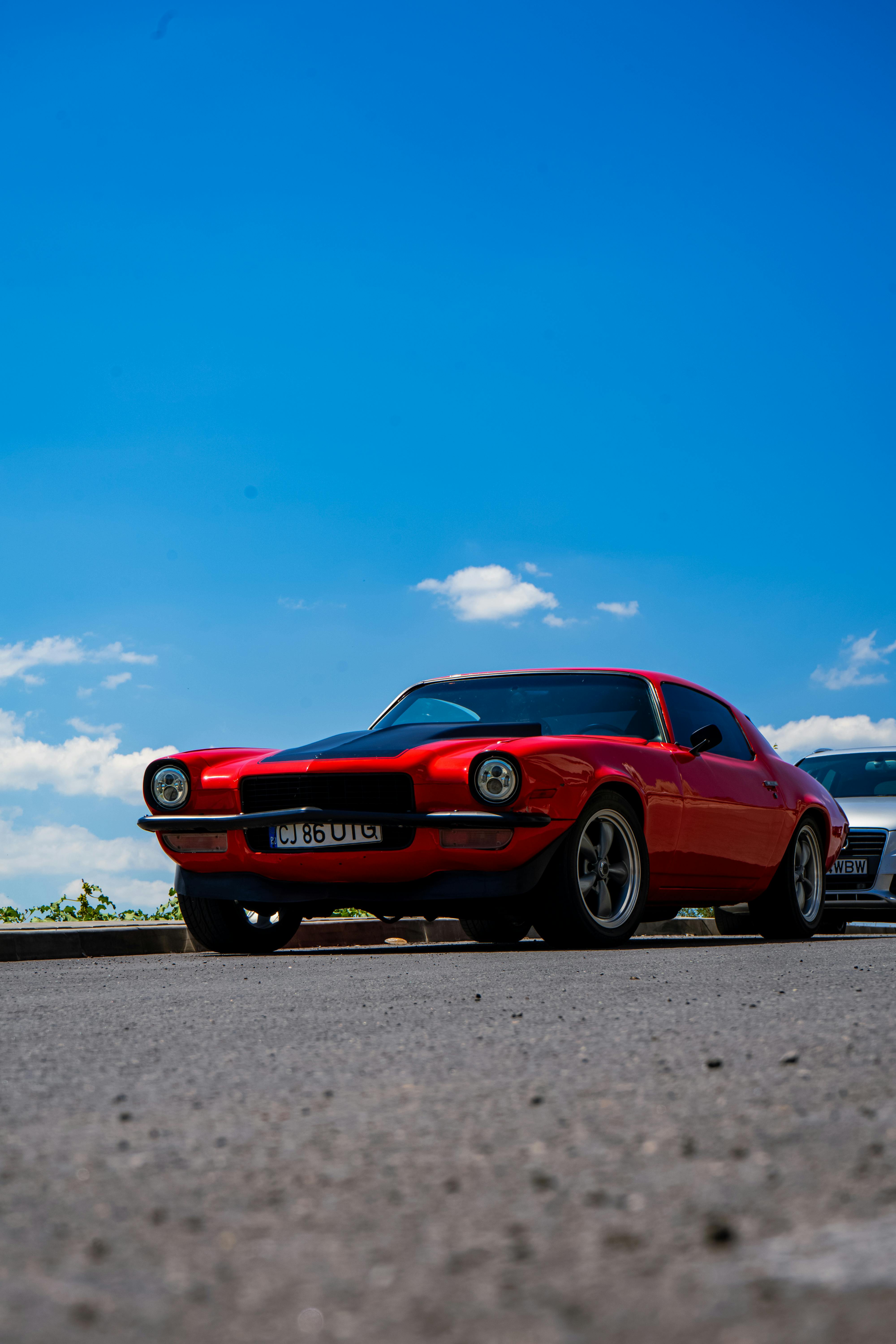 A Red Car Parked on the Street · Free Stock Photo