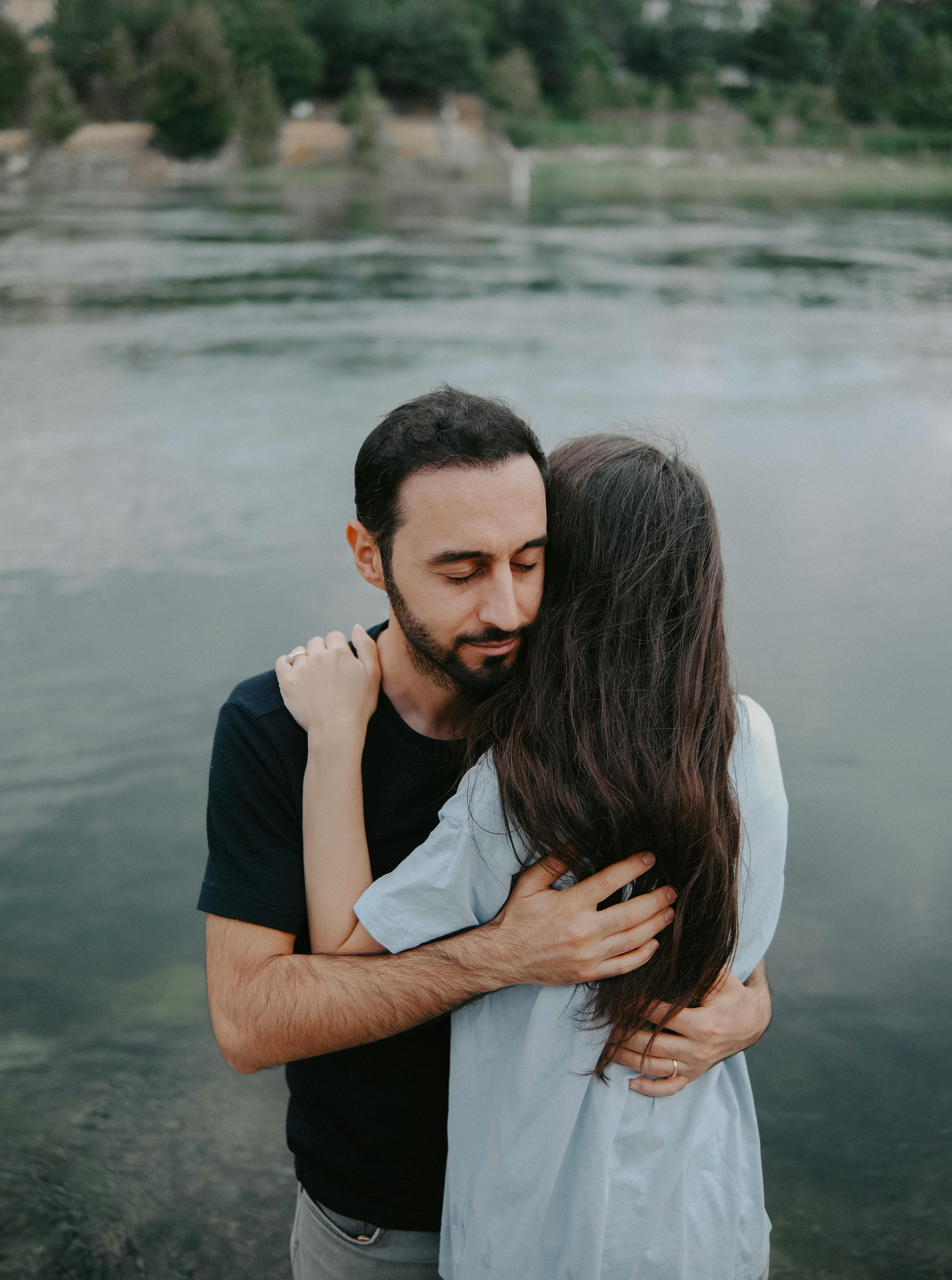 A Couple Wearing Jackets Hugging · Free Stock Photo