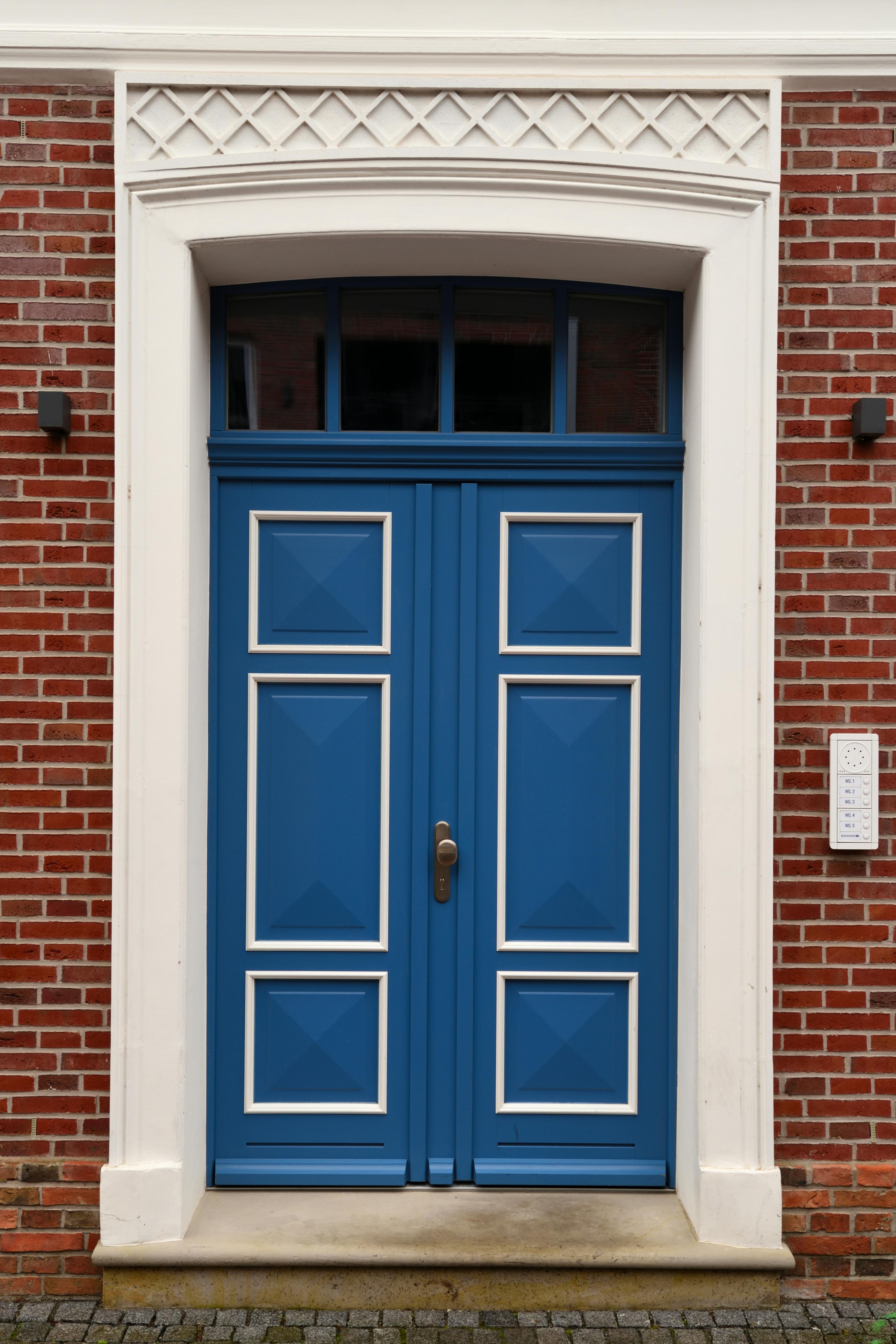Blue Doors of a Brick House · Free Stock Photo