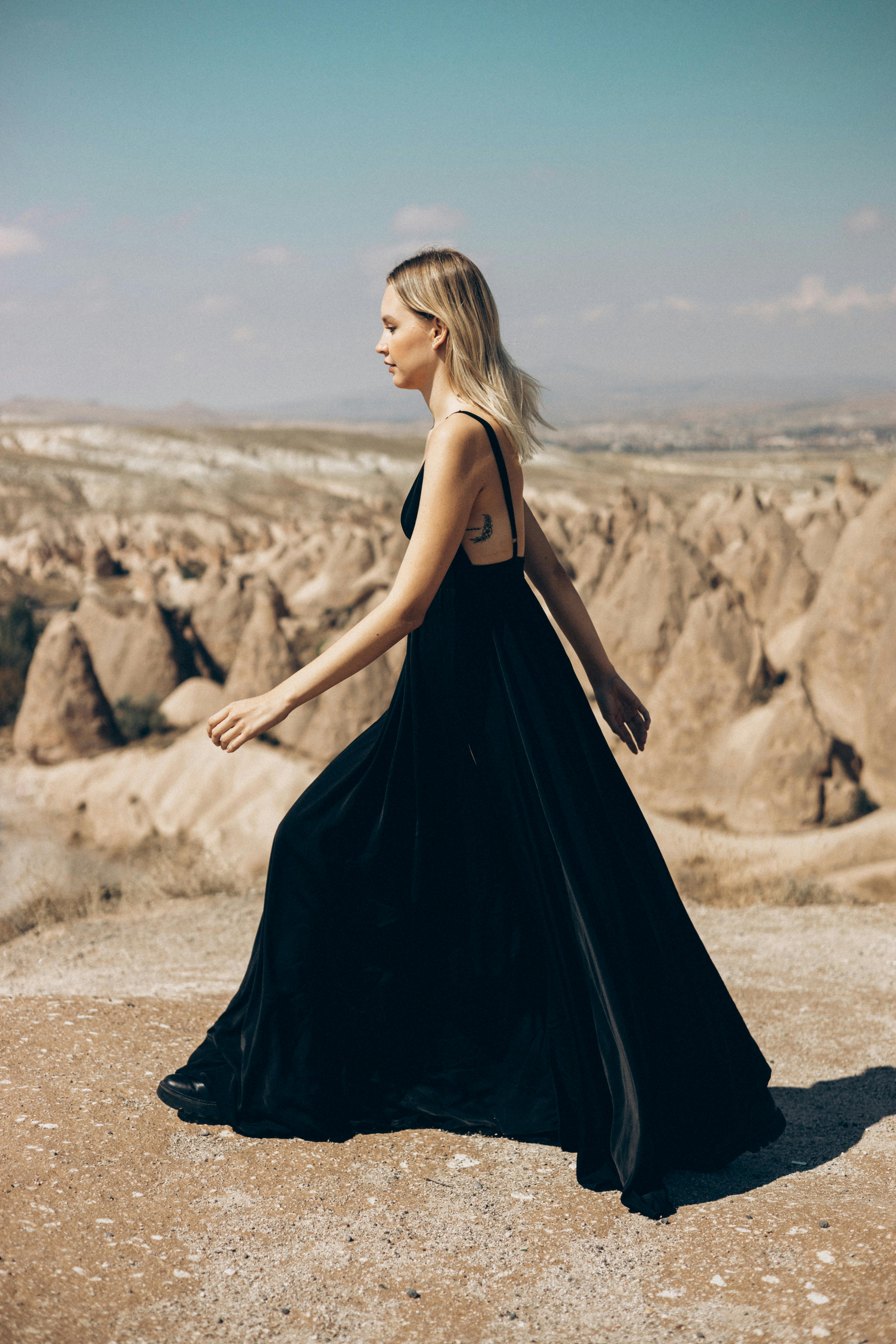 Side View of a Woman Wearing Black Dress · Free Stock Photo