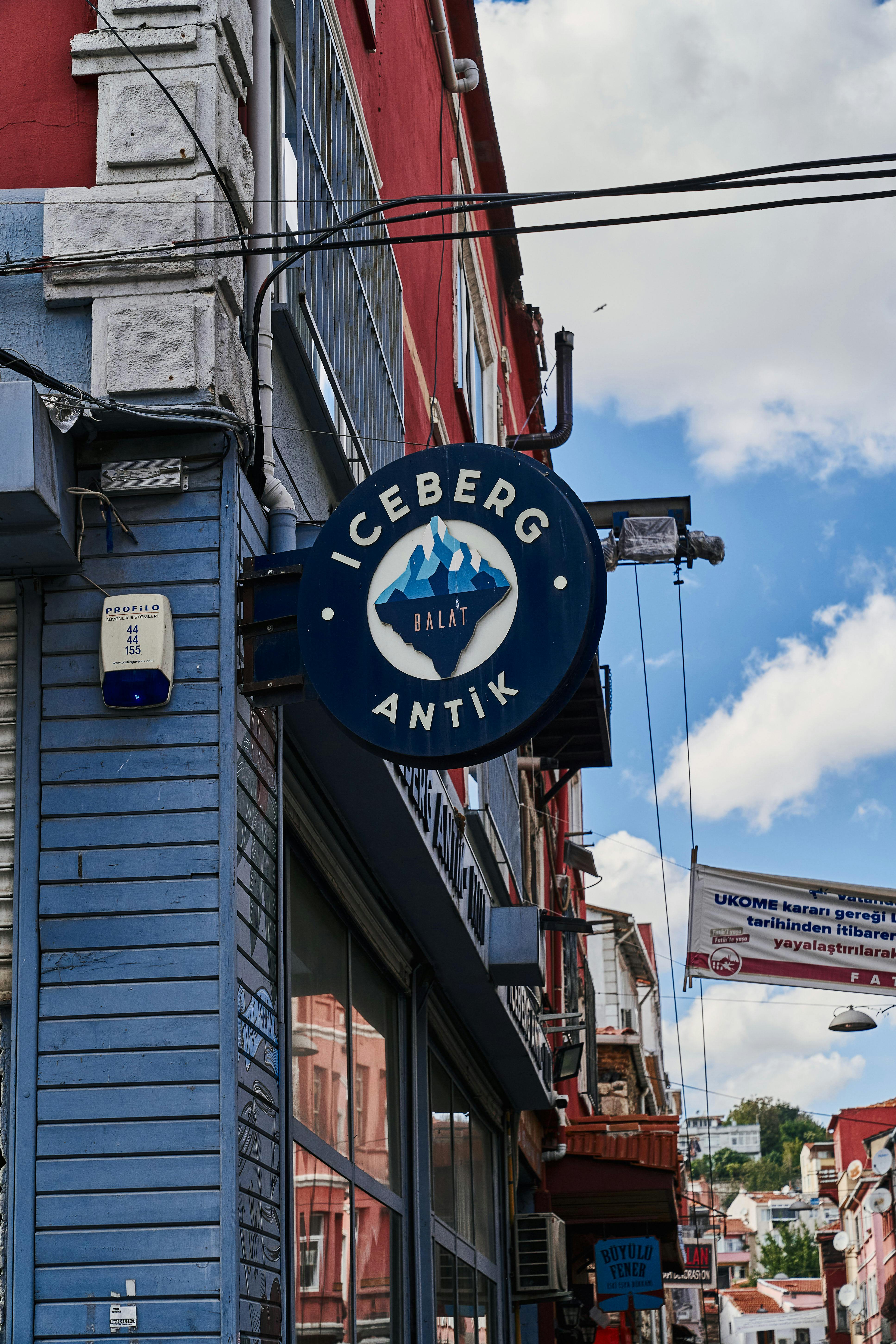 Red Metal Chair and a Wooden Table at a Storefront · Free Stock Photo
