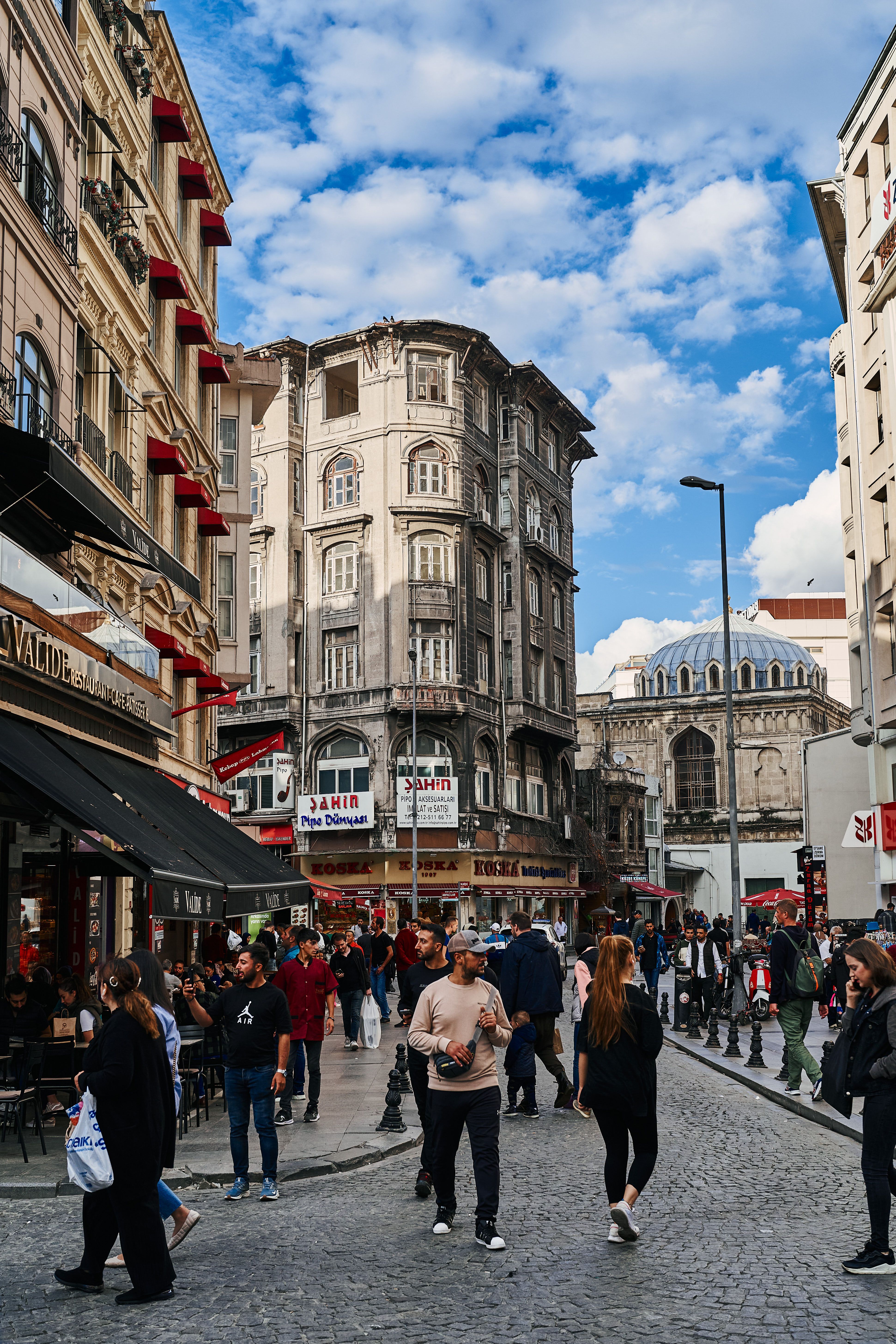 People Walking on the Street Between Buildings · Free Stock Photo