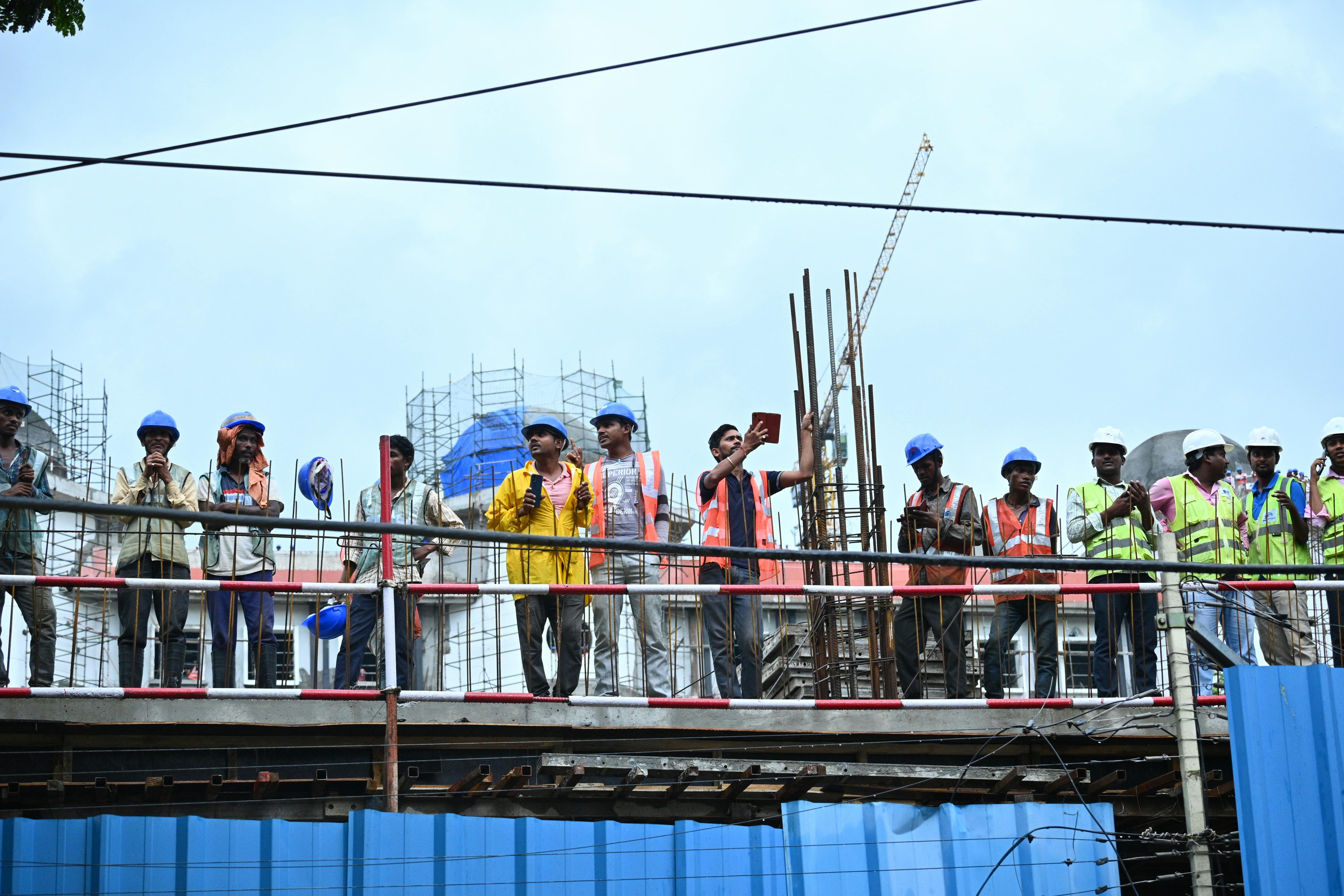 Men in Helmets Working on Scaffolding on Building Site · Free Stock Photo