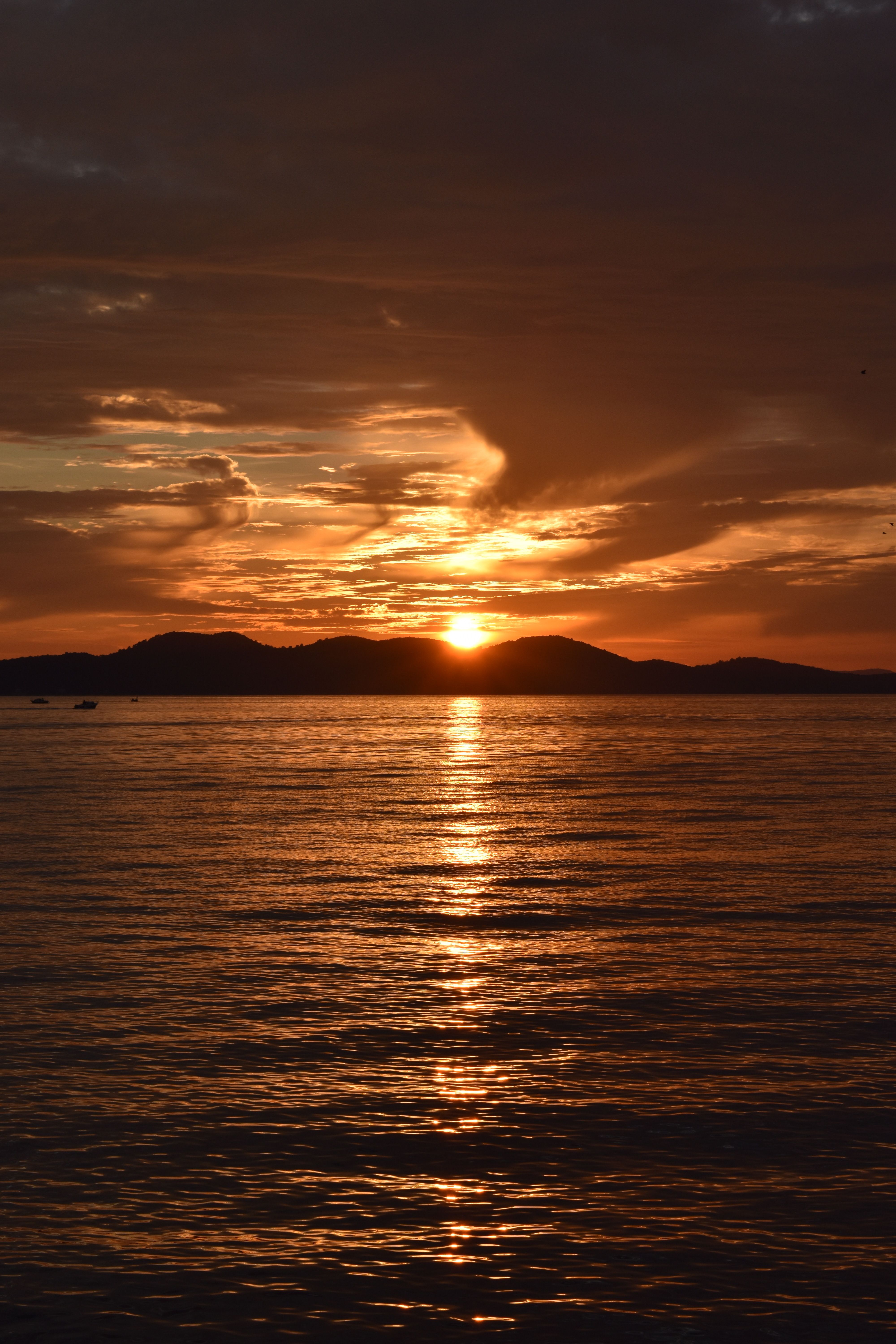 Sunset under Clouds on Sea Shore · Free Stock Photo