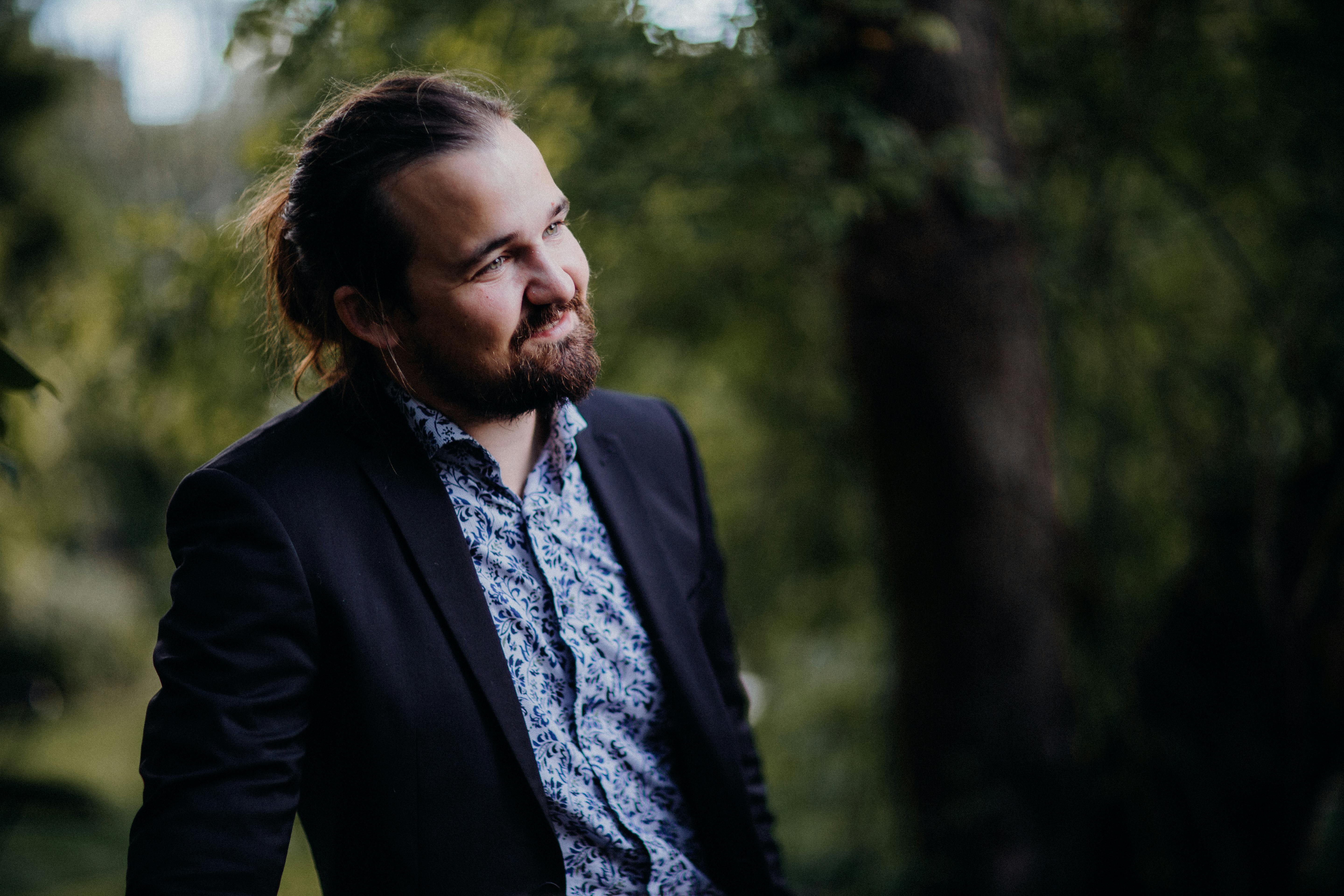 A Man Pointing Up while Smiling · Free Stock Photo