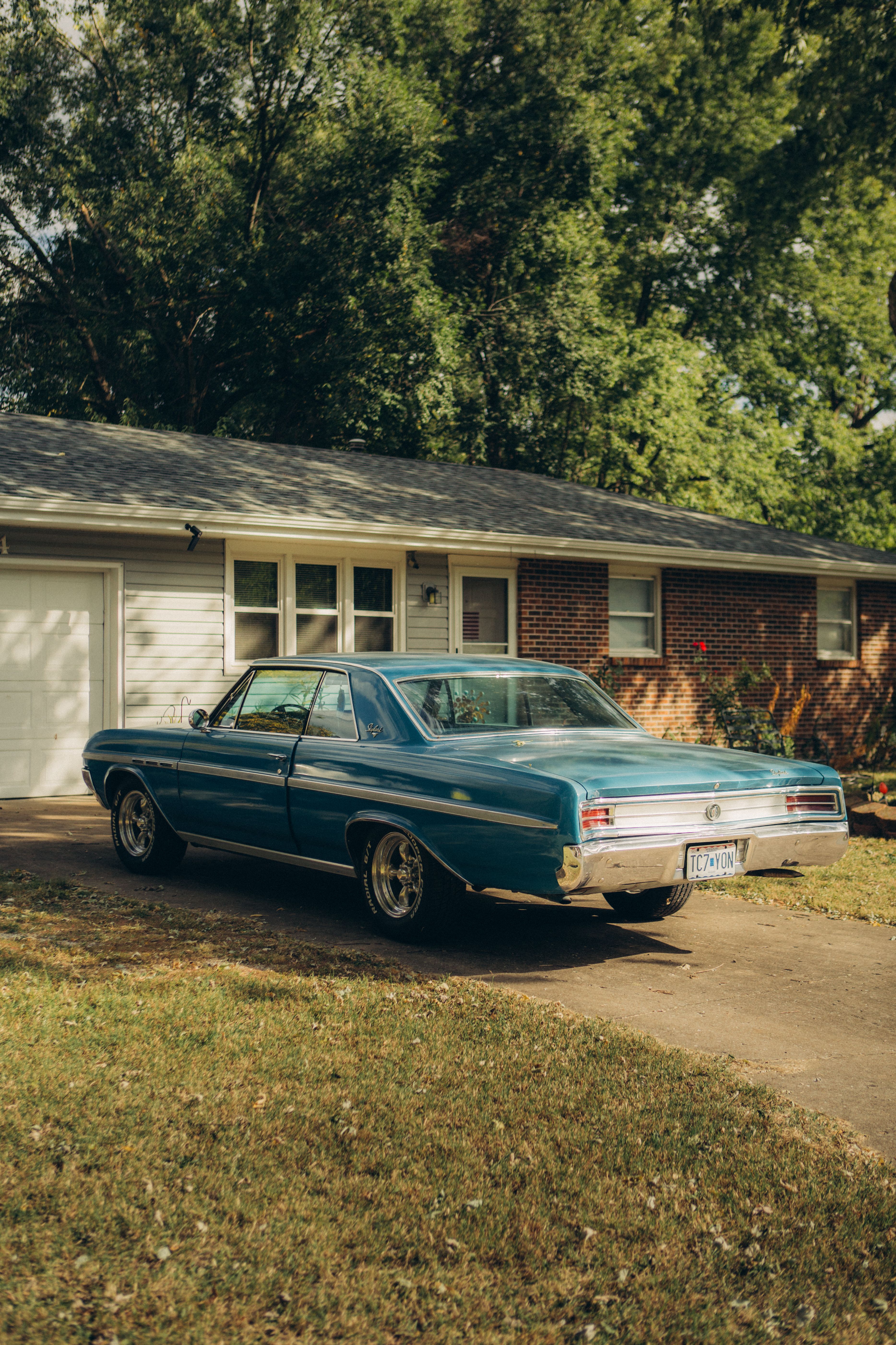 A Vintage Car on a Driveway · Free Stock Photo
