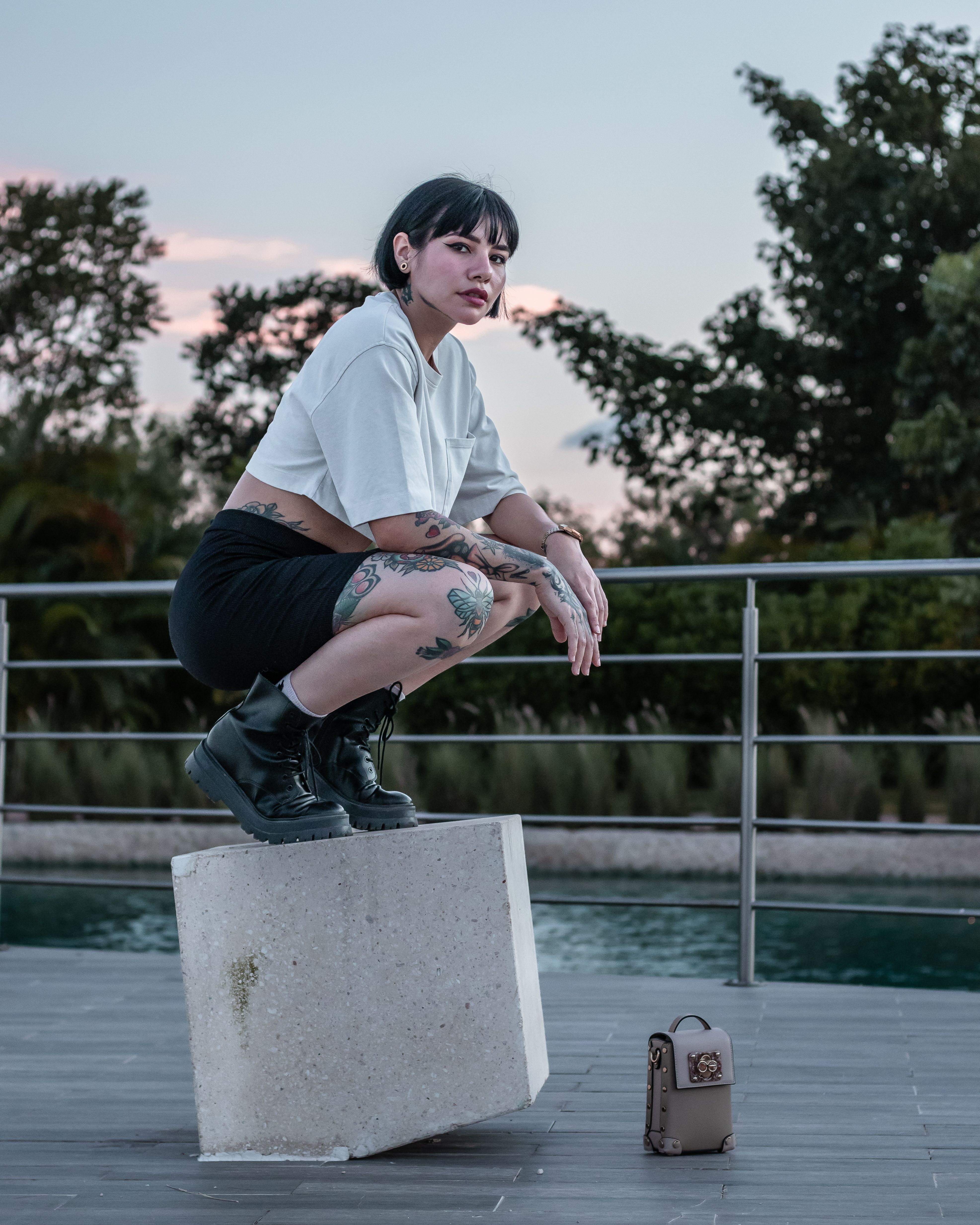 A Woman in a Crop Top and Biker Shorts Crouching on a Block · Free ...