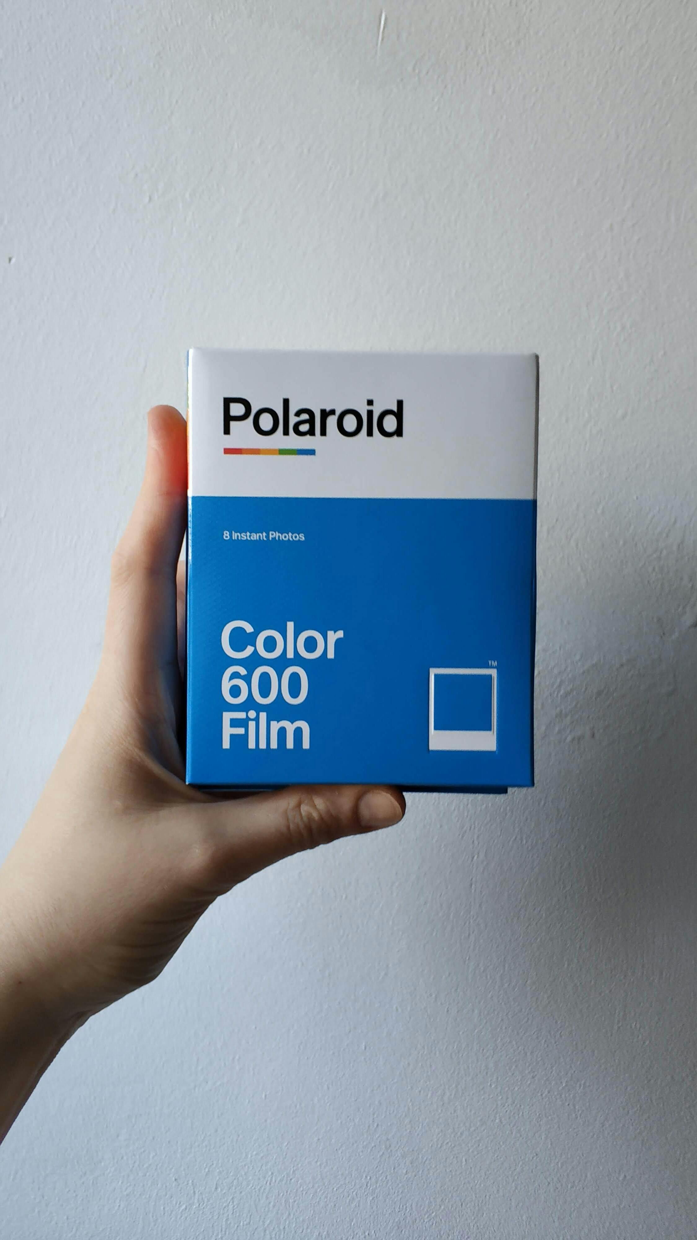 A Person Holding Polaroid Color Film Box · Free Stock Photo