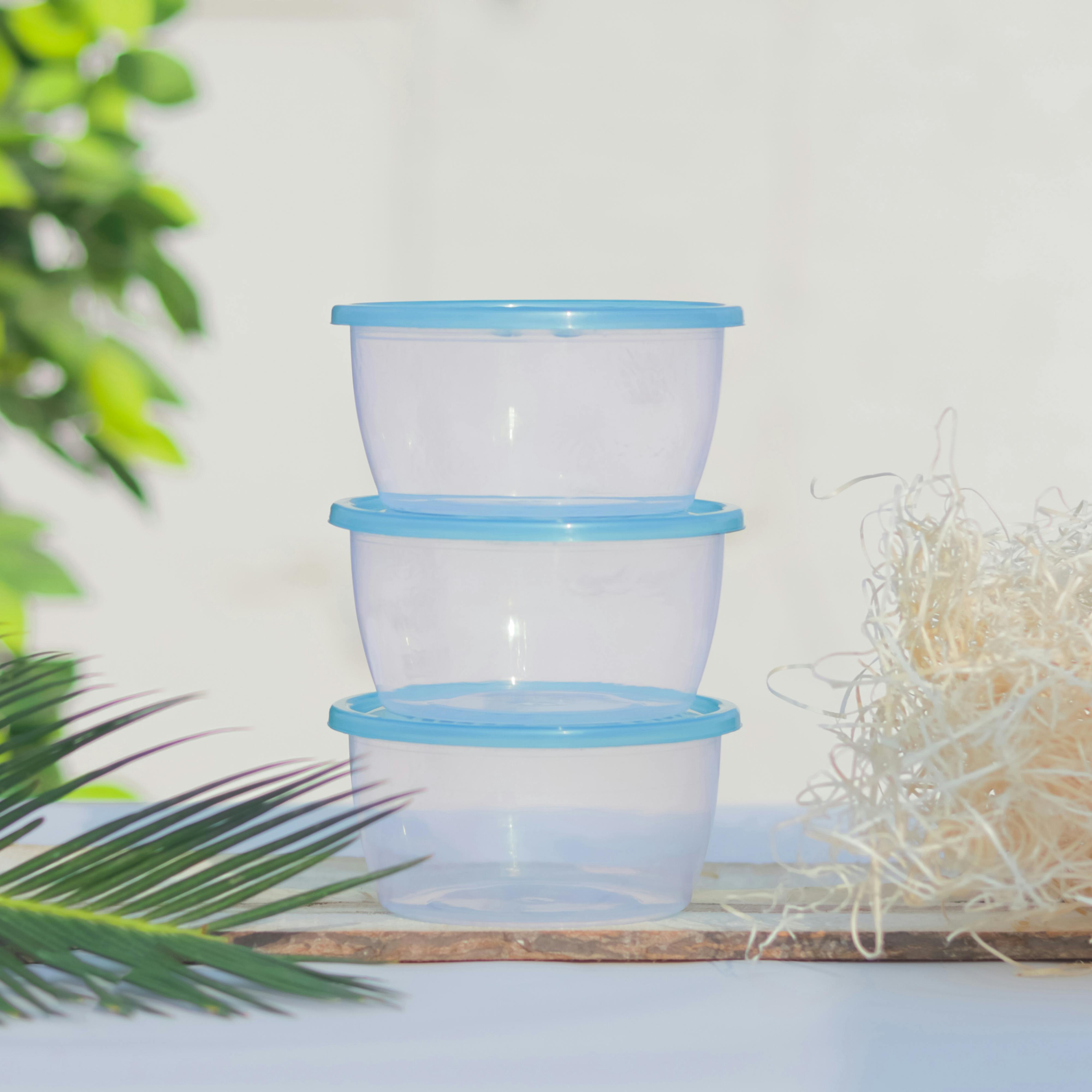 A Stack of Plastic Containers with Blue Lids · Free Stock Photo