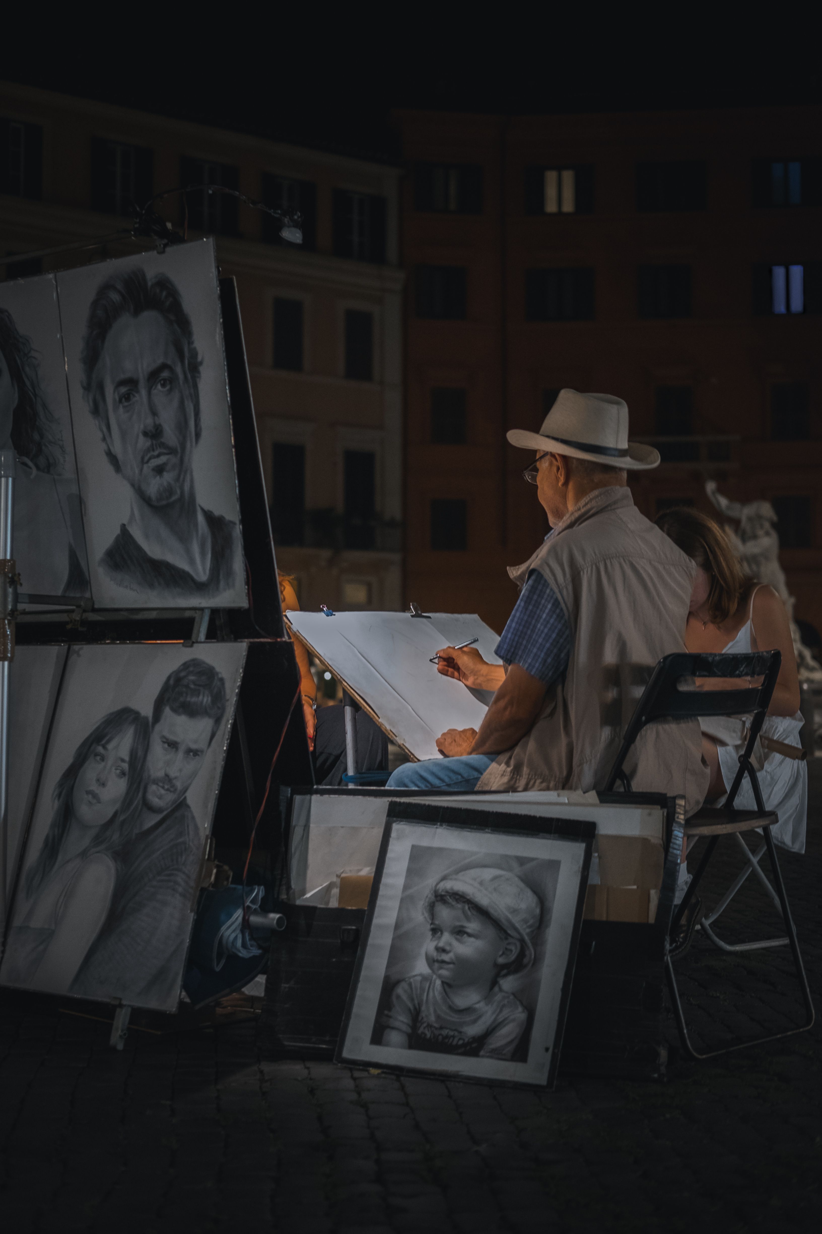 Sitting Man Looking at Drawings · Free Stock Photo