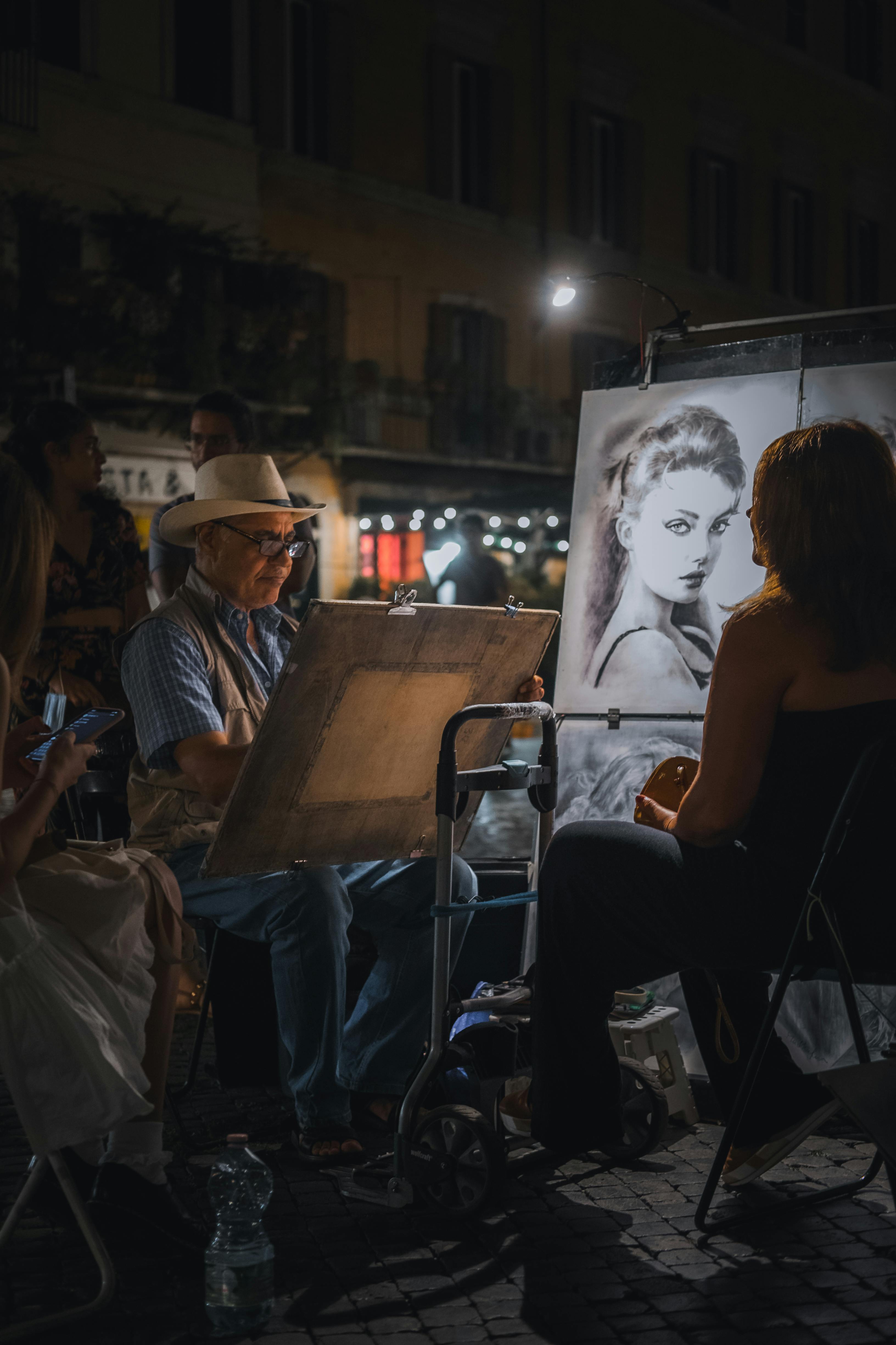A Man Drawing Portraits on a Street · Free Stock Photo