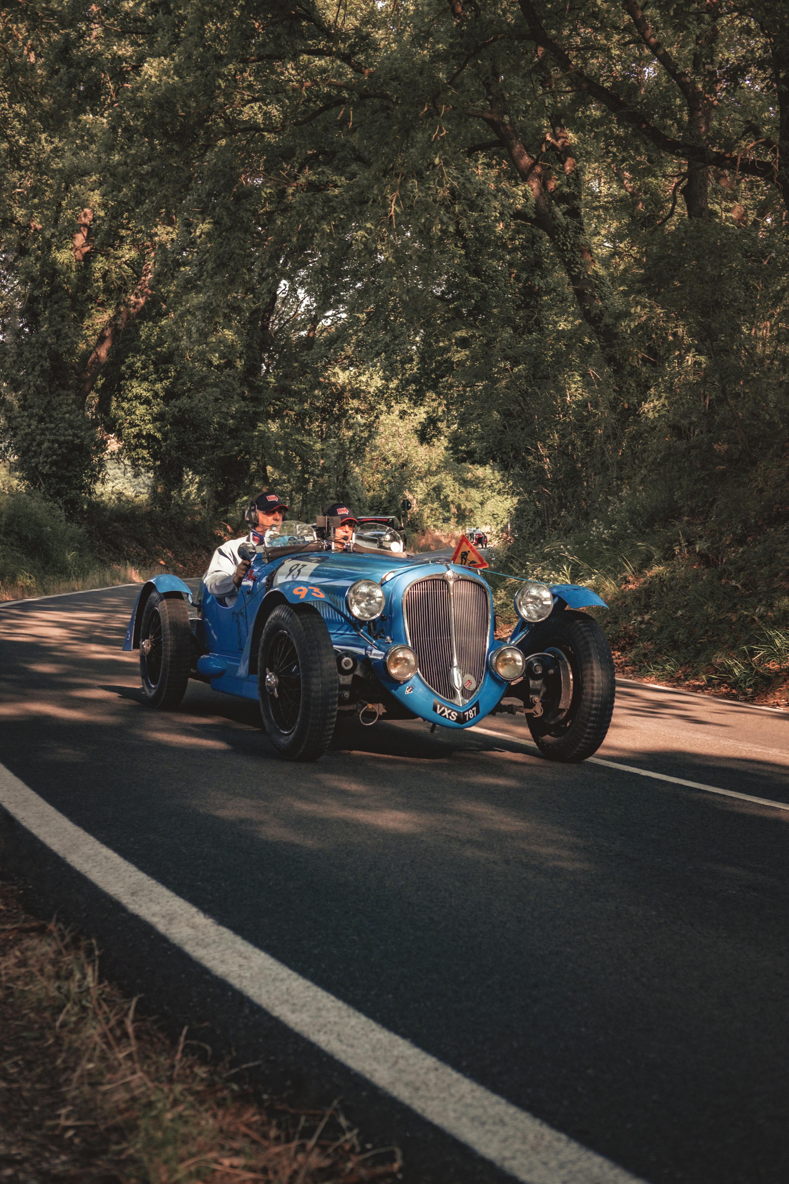 Retro Car Driving on Road in Forest · Free Stock Photo