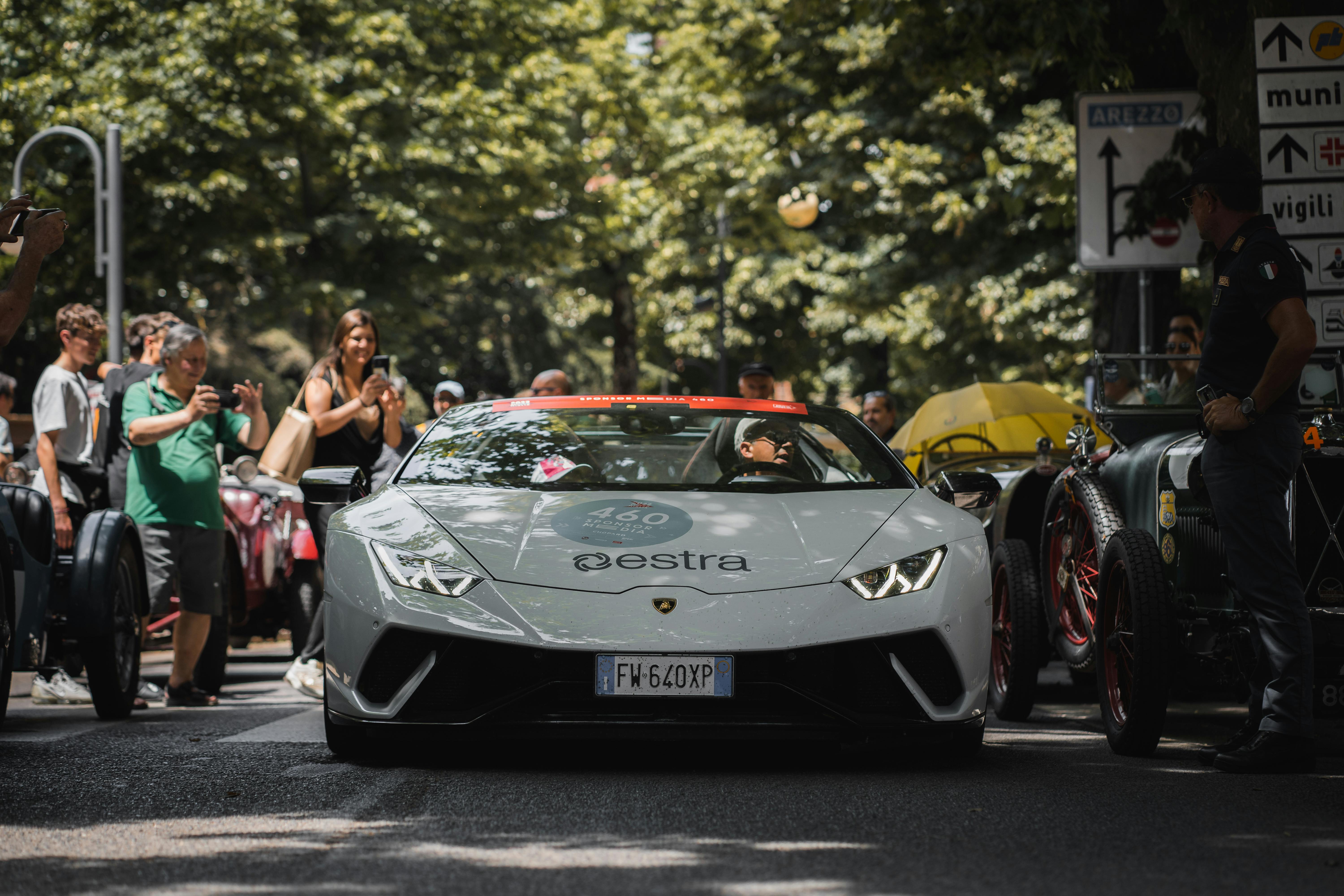 People Photographing Sports Car in a Park · Free Stock Photo