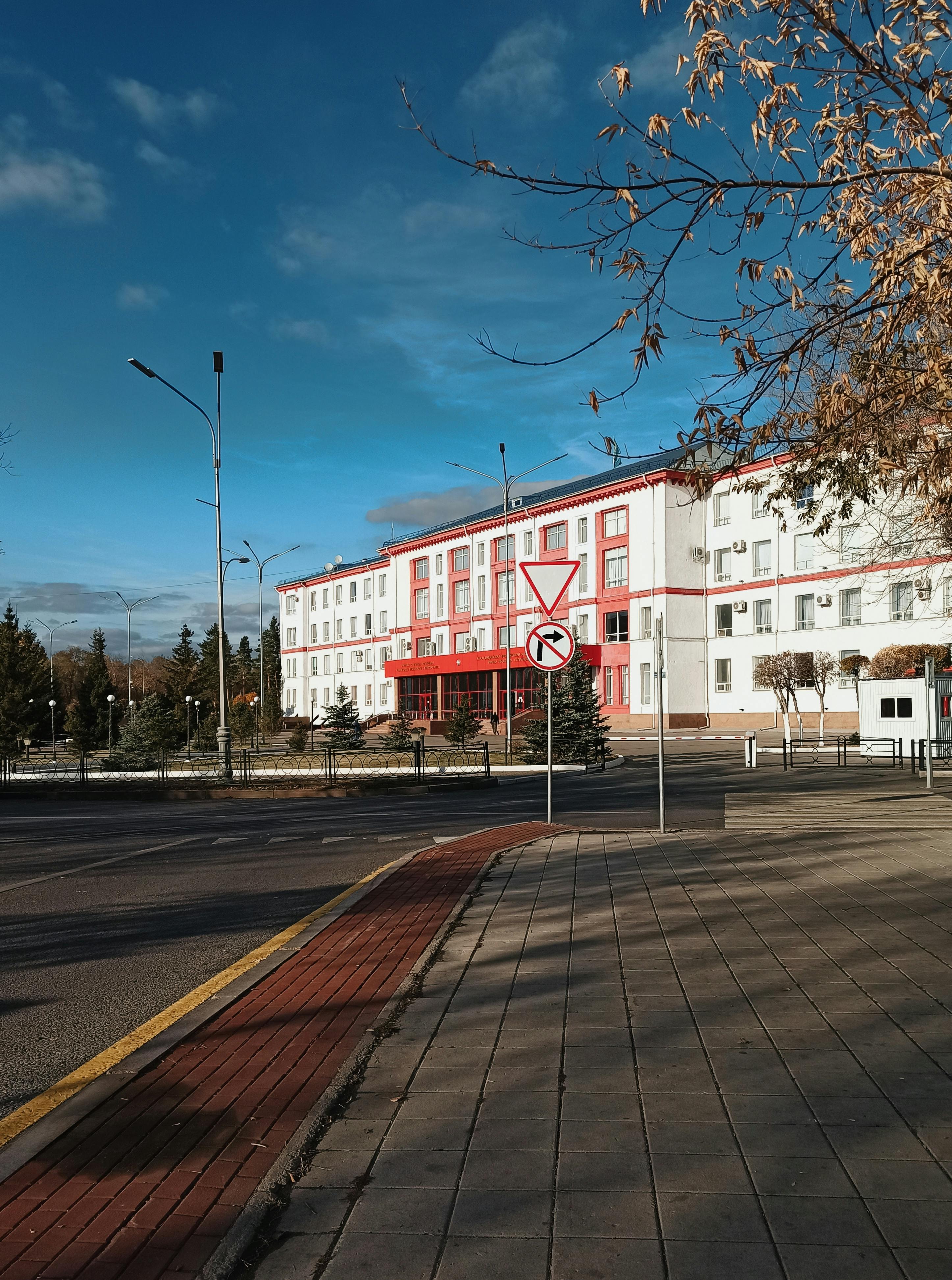 White and Red Concrete Building Near the Road · Free Stock Photo