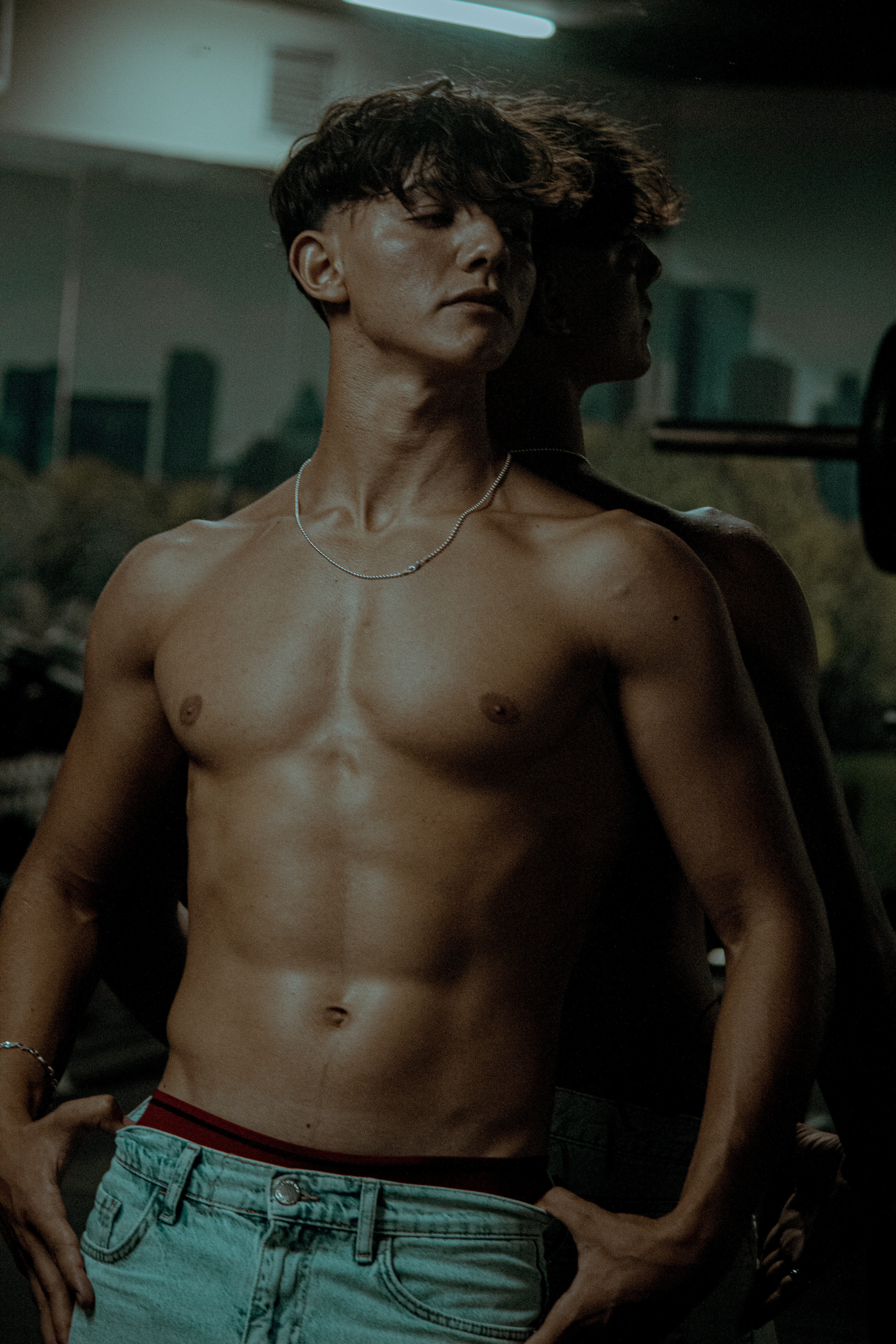 Shirtless Man Standing with his Back to Mirror · Free Stock Photo