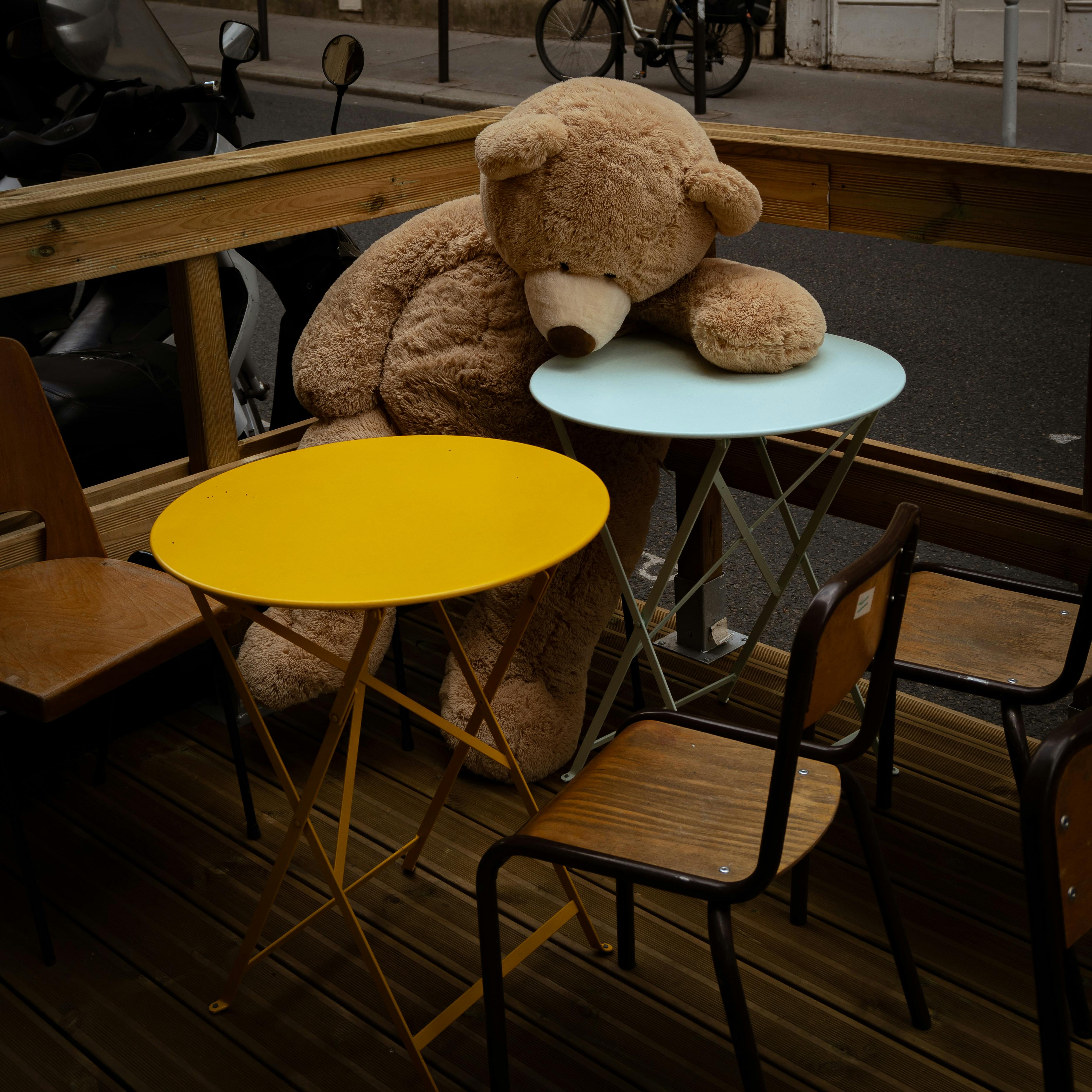 A Brown Teddy Bear Sitting at the Table · Free Stock Photo