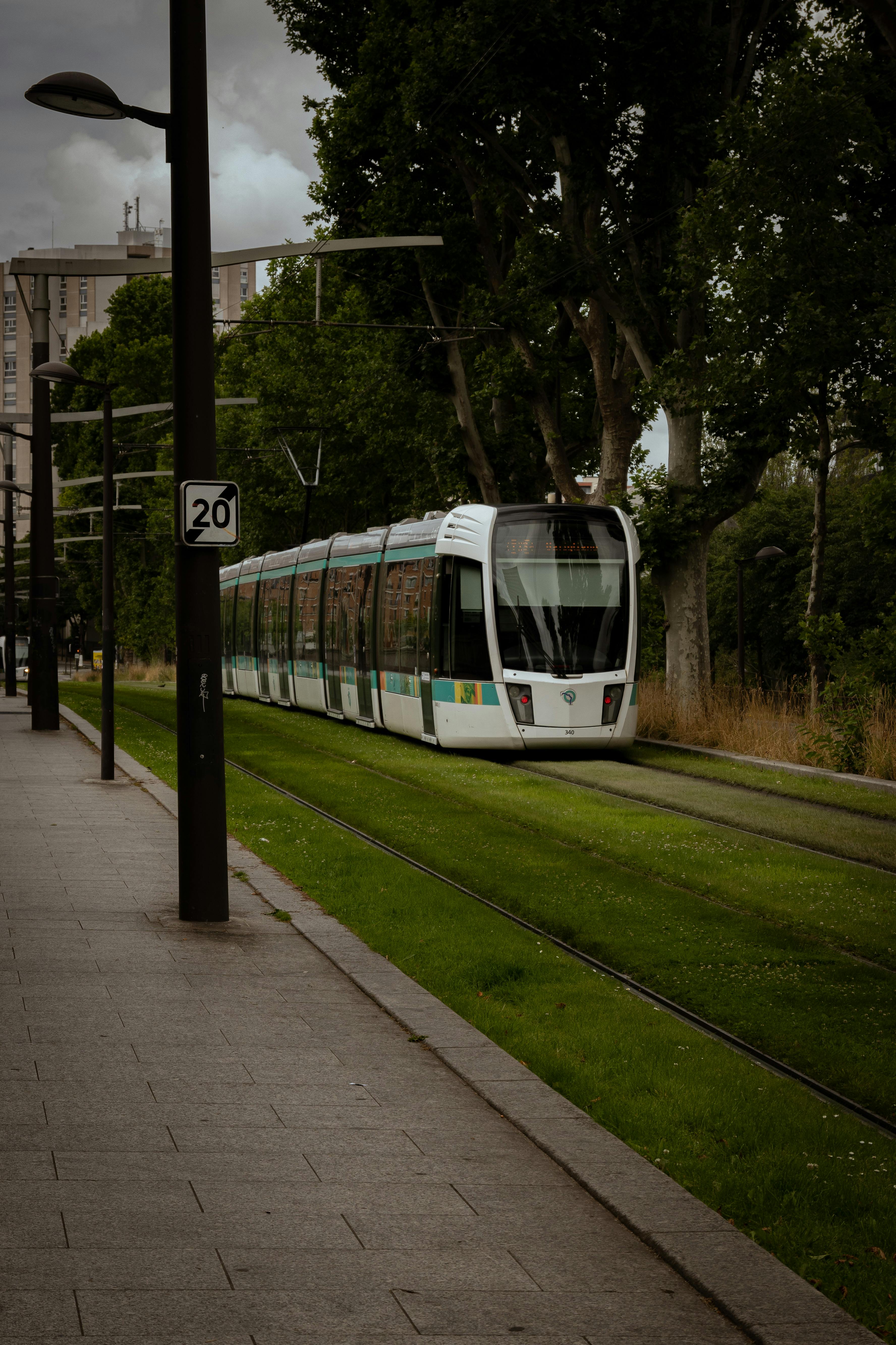 Tram Driving on Green Tracks · Free Stock Photo