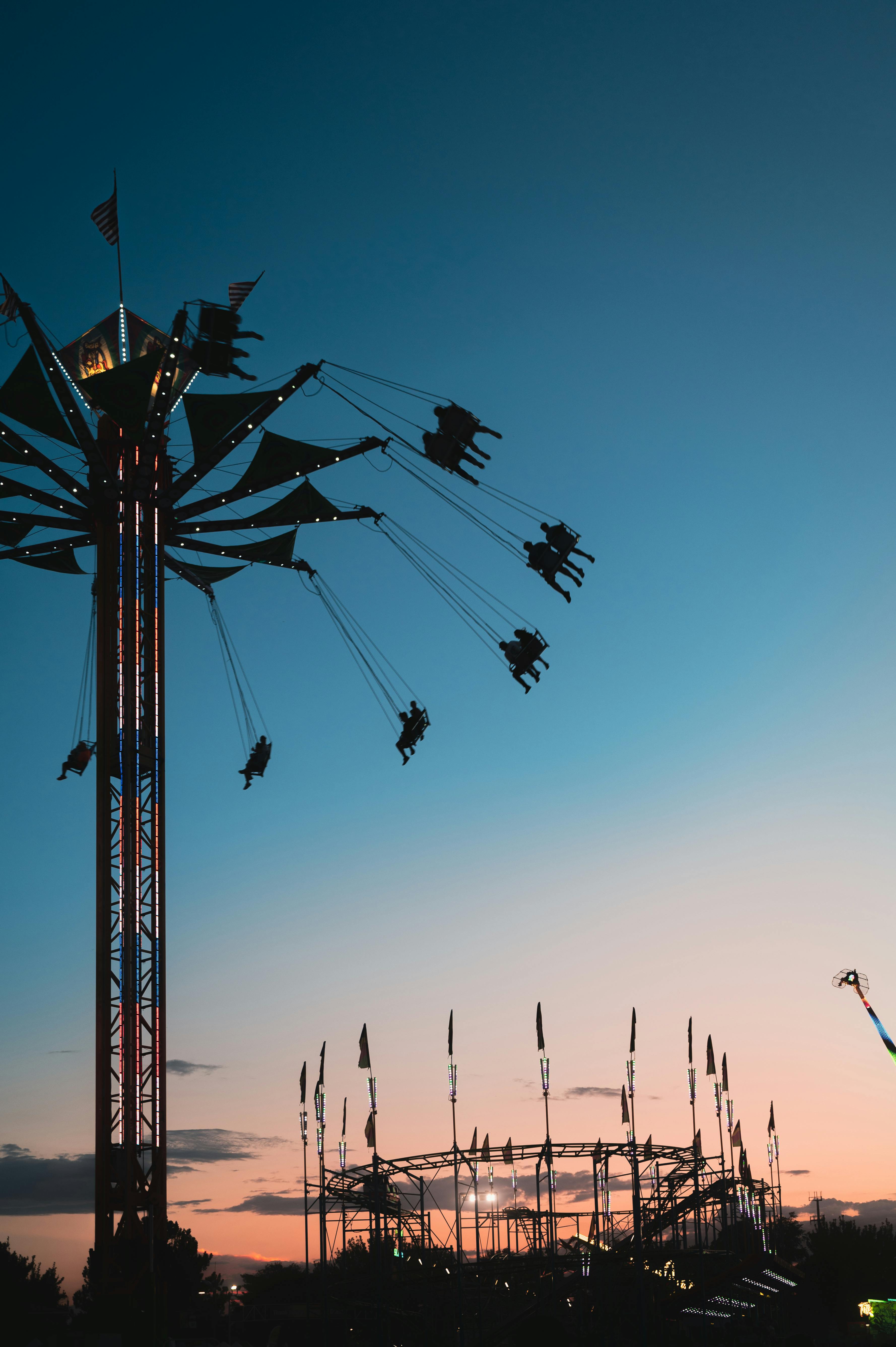 Silhouette of People Riding on Amusement Park Ride · Free Stock Photo