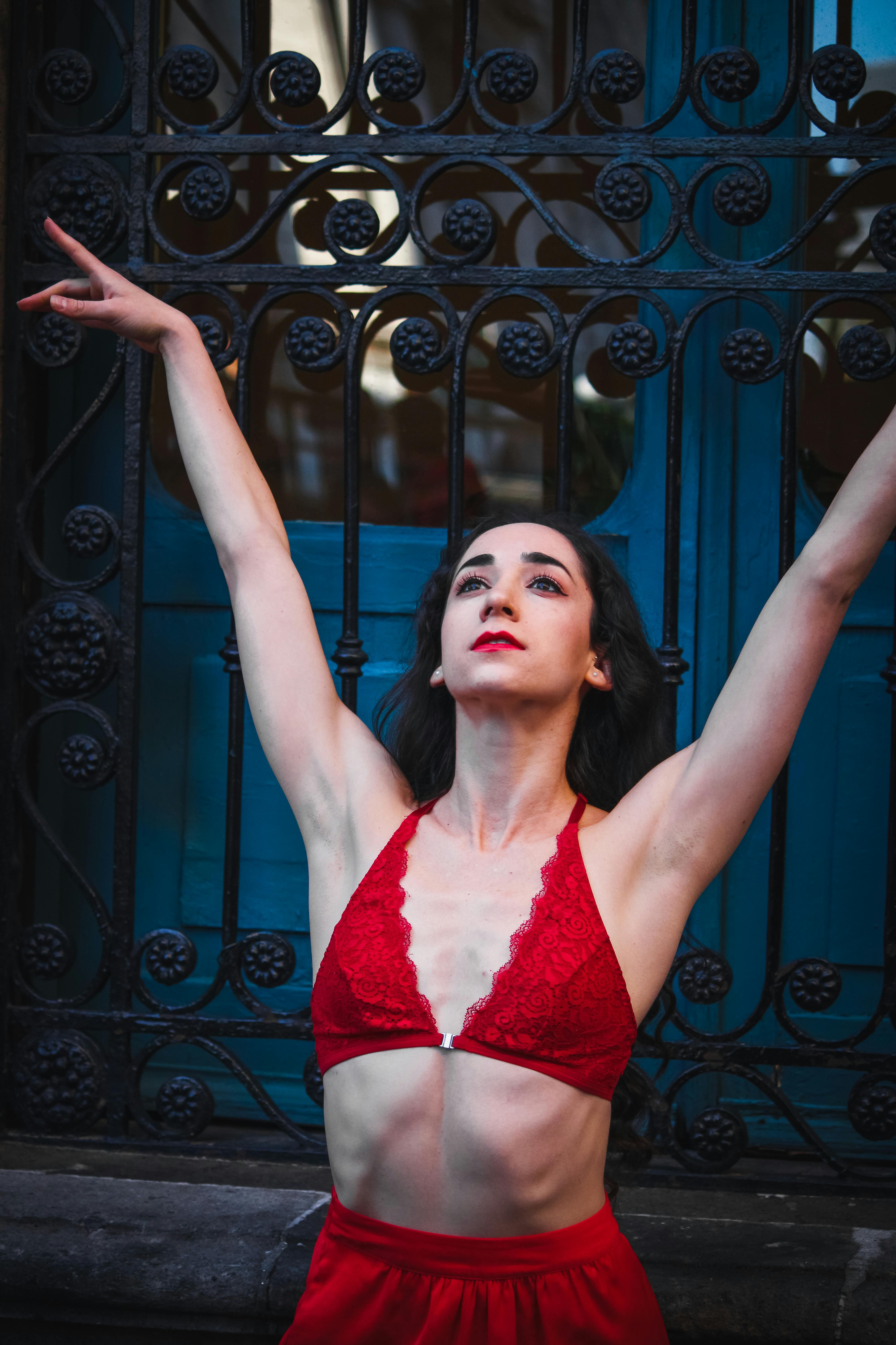 Woman in a Red Bra Raising her Arms · Free Stock Photo