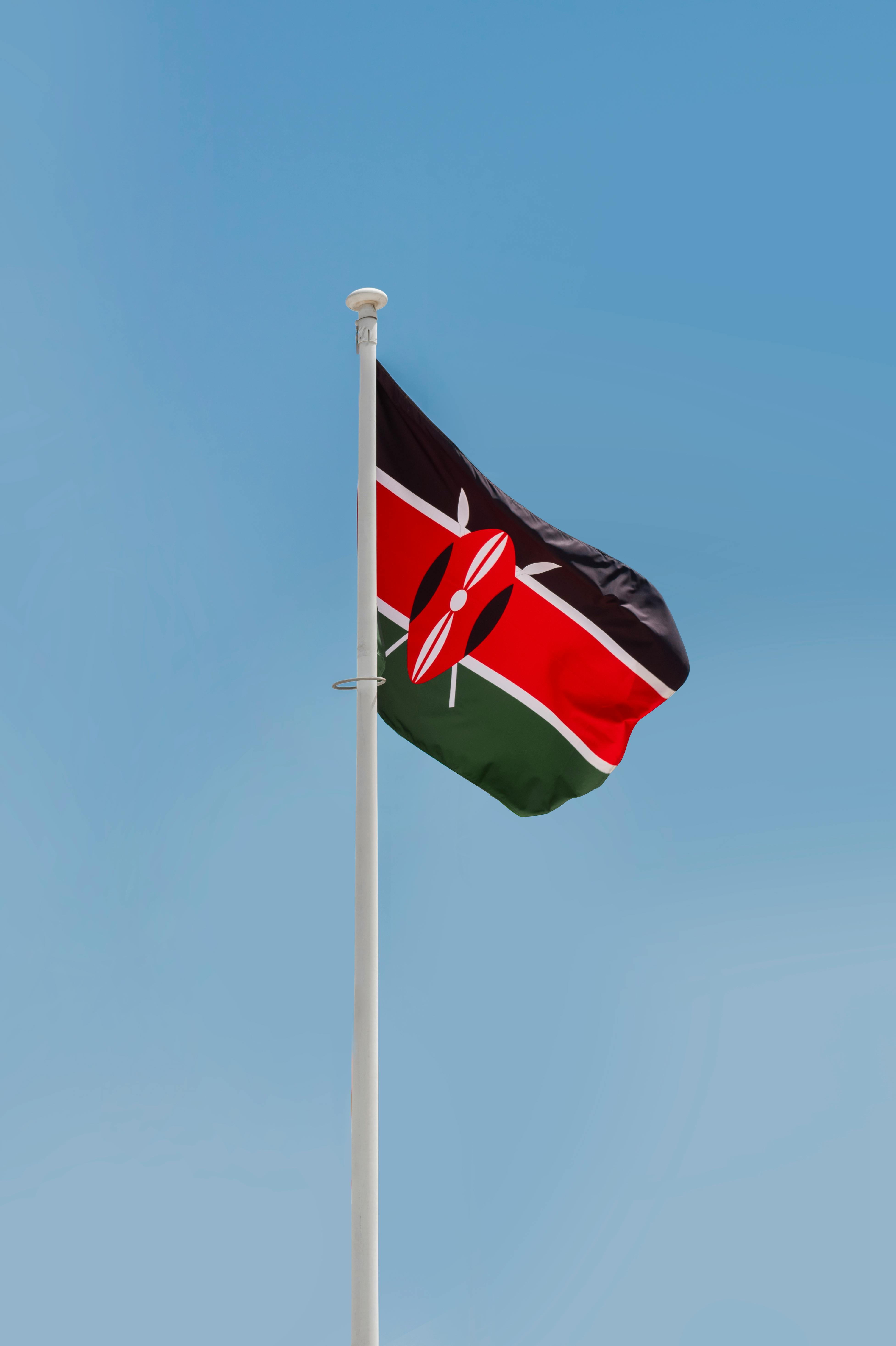 Kenya National Flag Under Blue Sky · Free Stock Photo