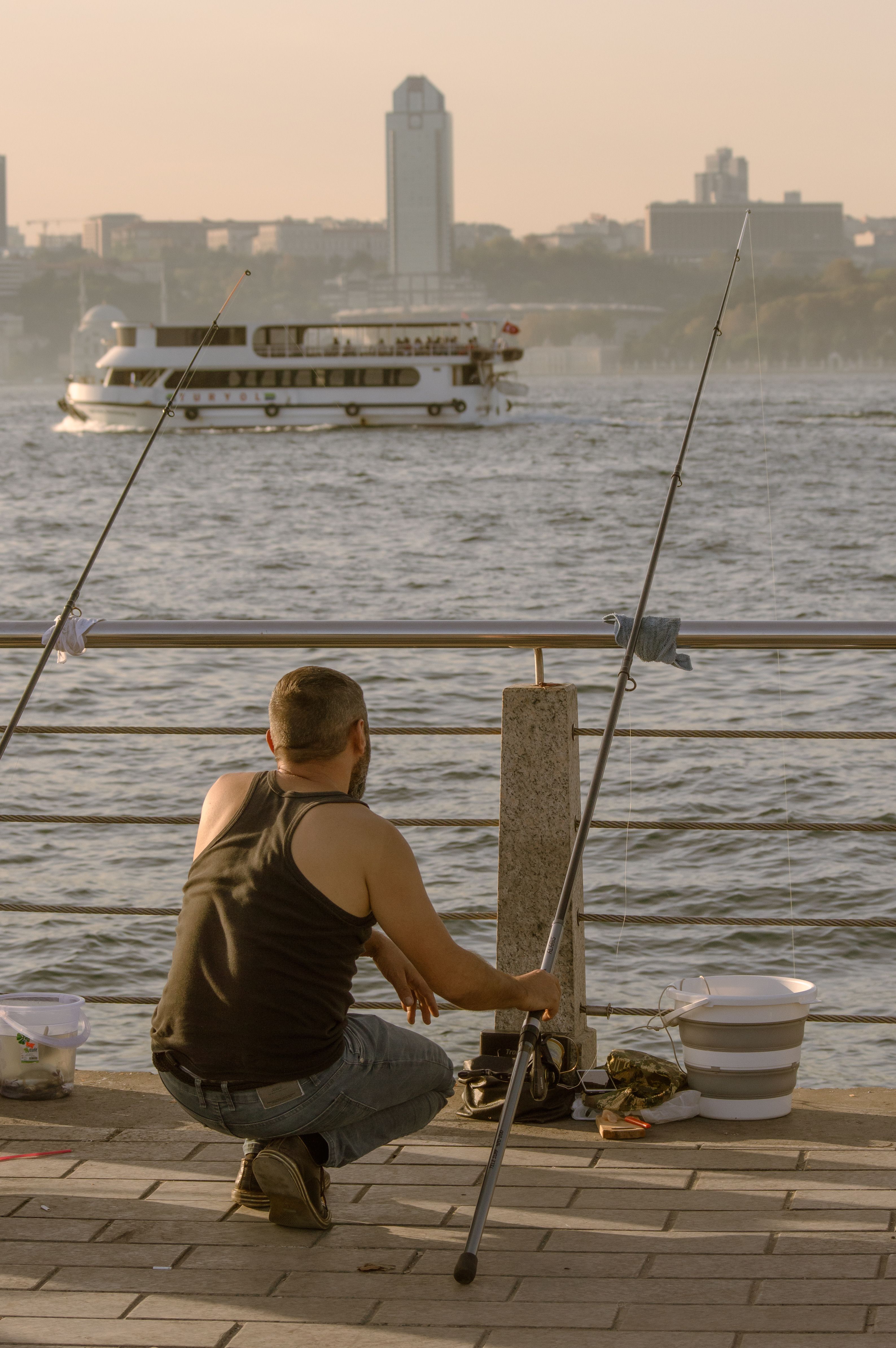 Back View of a Man Sitting while Fishing · Free Stock Photo