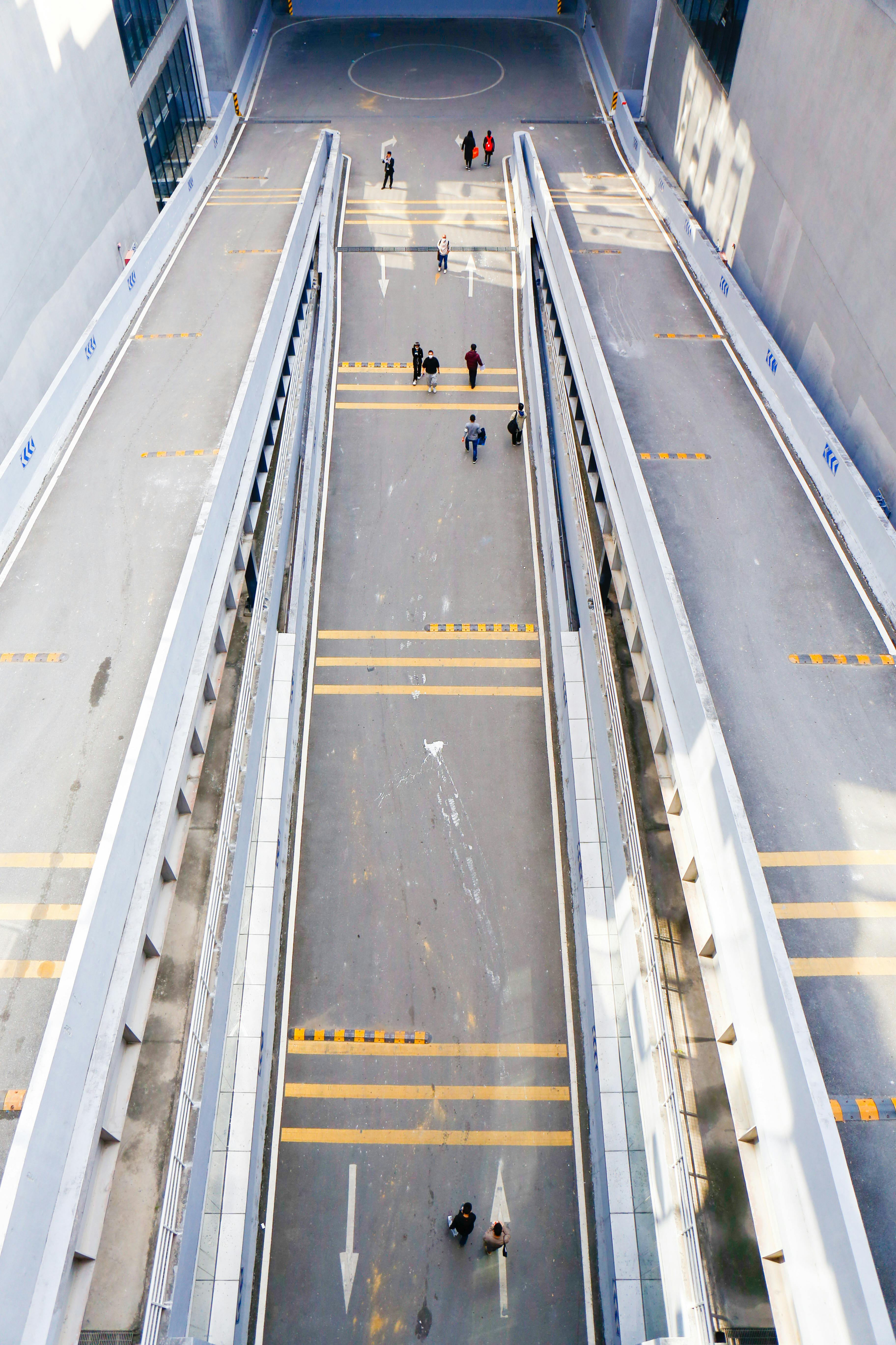 People Walking Up on Elevated Driveway · Free Stock Photo