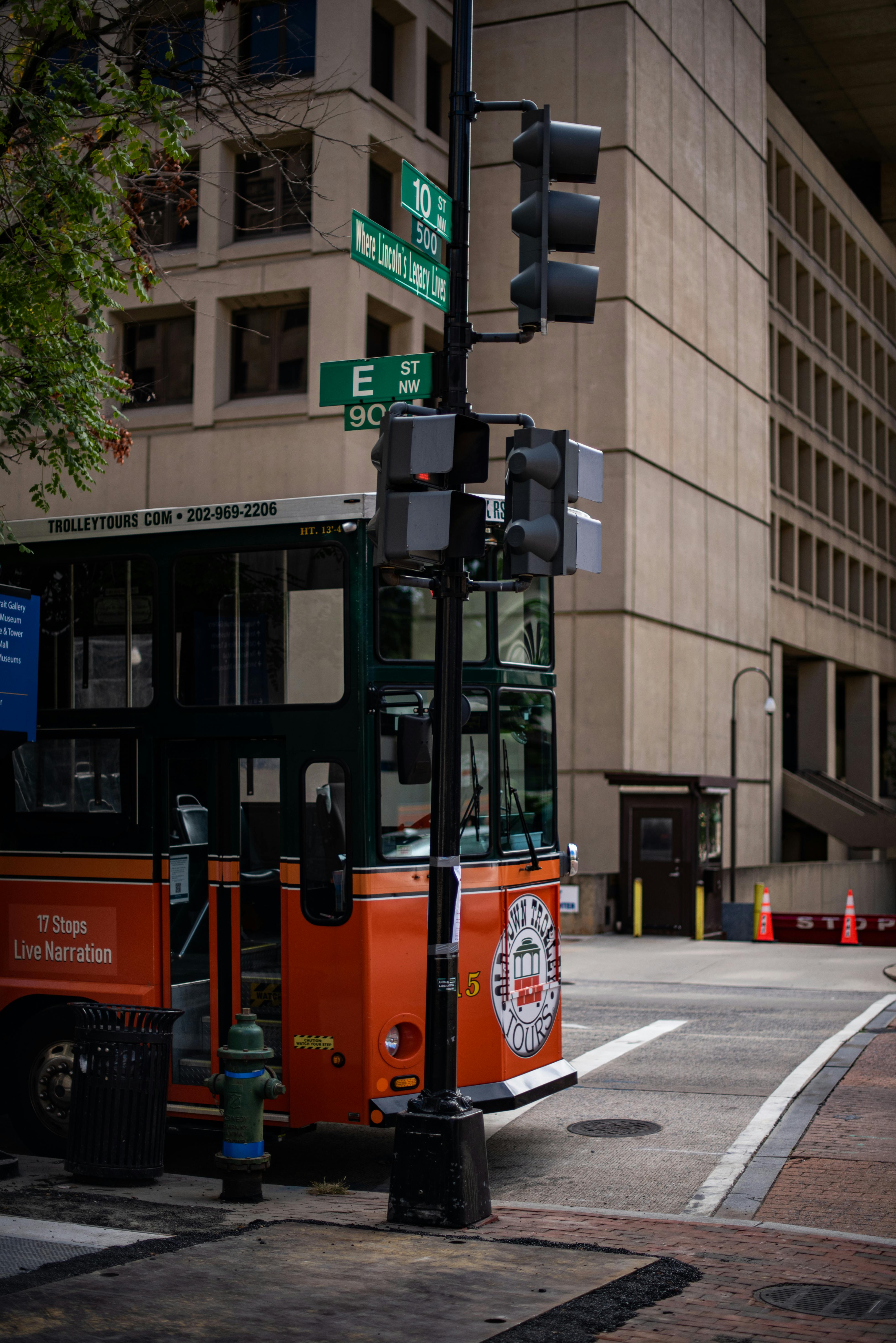 Red Bus Stopping Beside a Traffic Light · Free Stock Photo