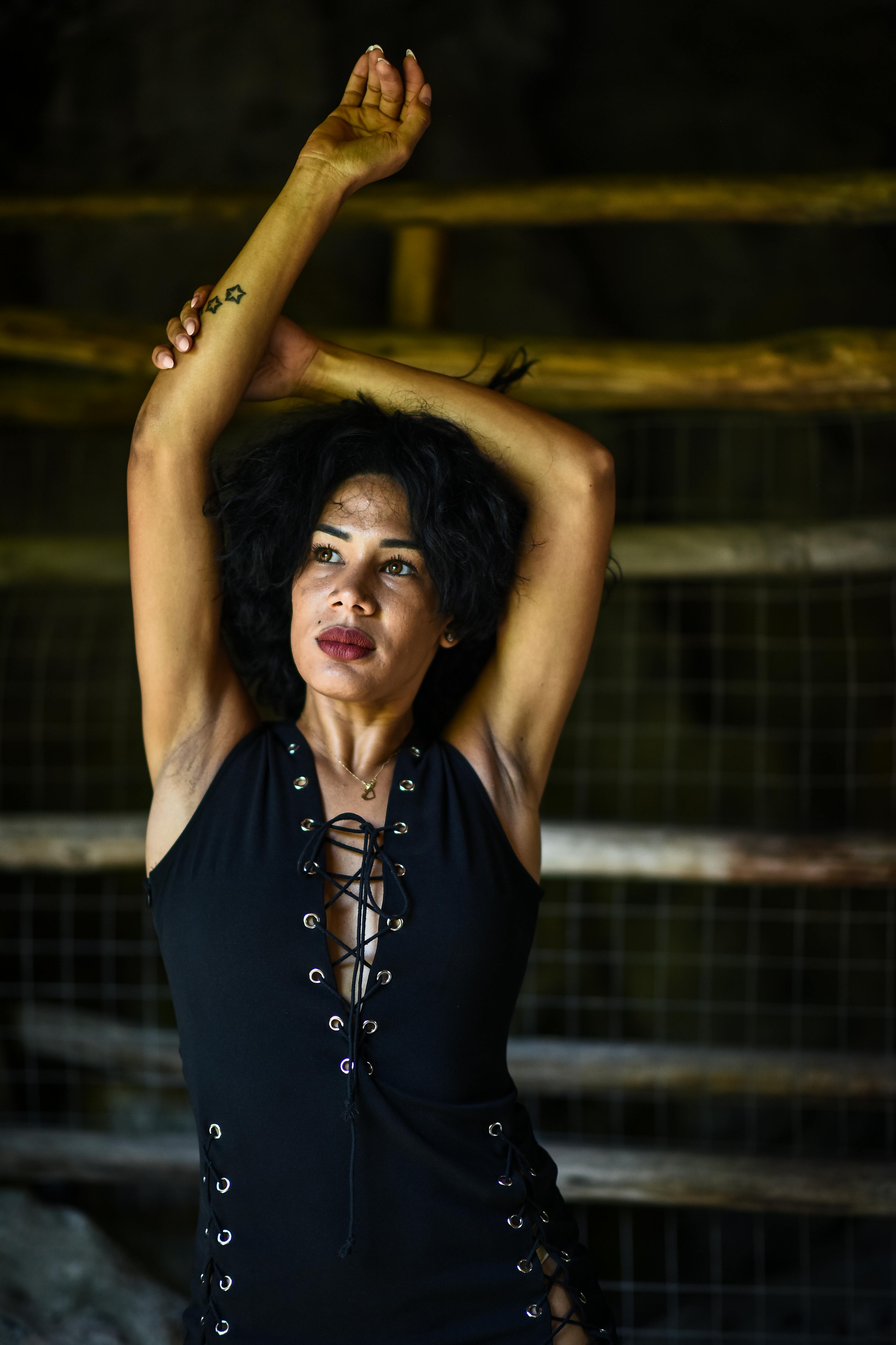 Woman in Black Dress With Hands Raised over Her Head · Free Stock Photo