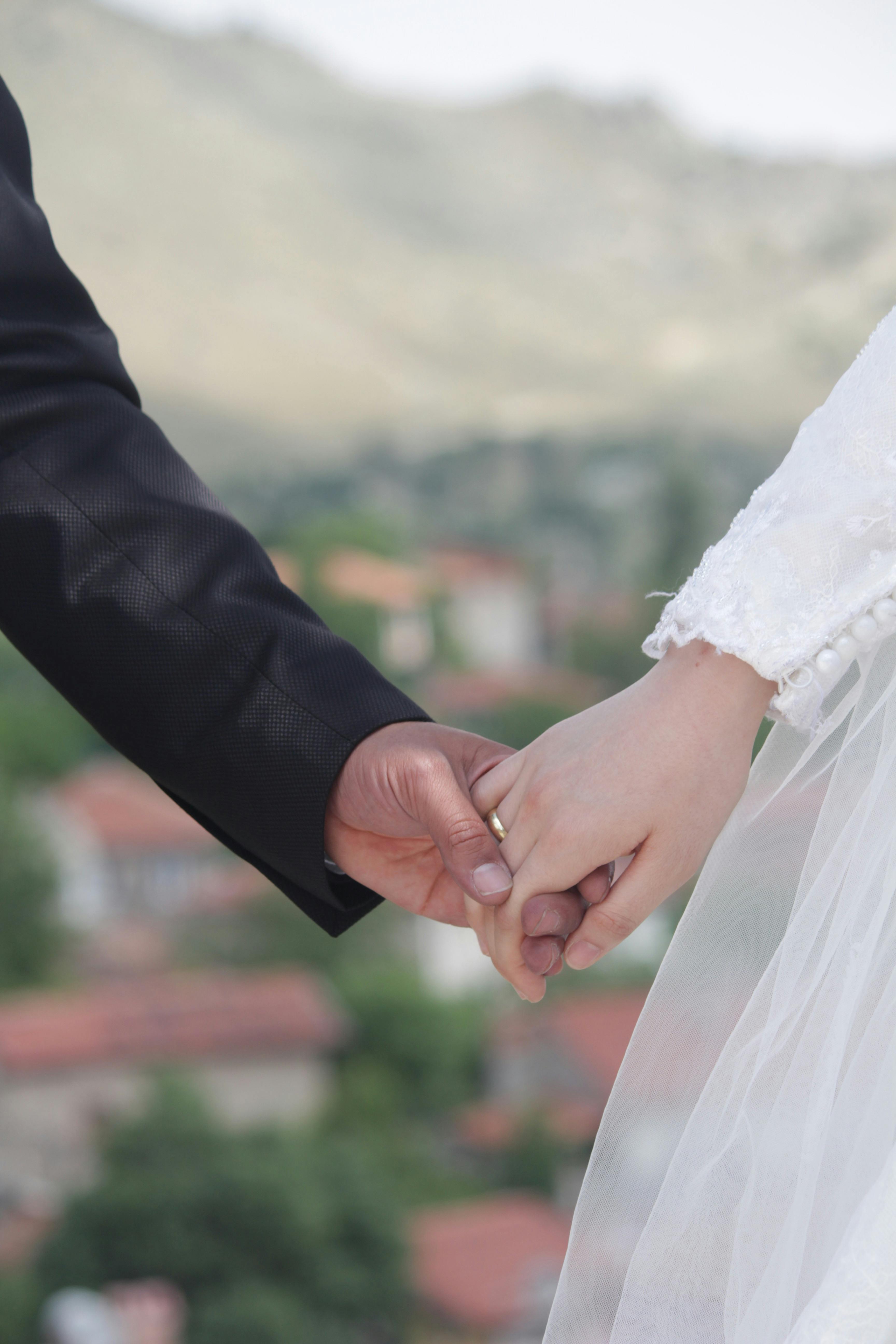Bride and Groom Holding Hands Photo · Free Stock Photo
