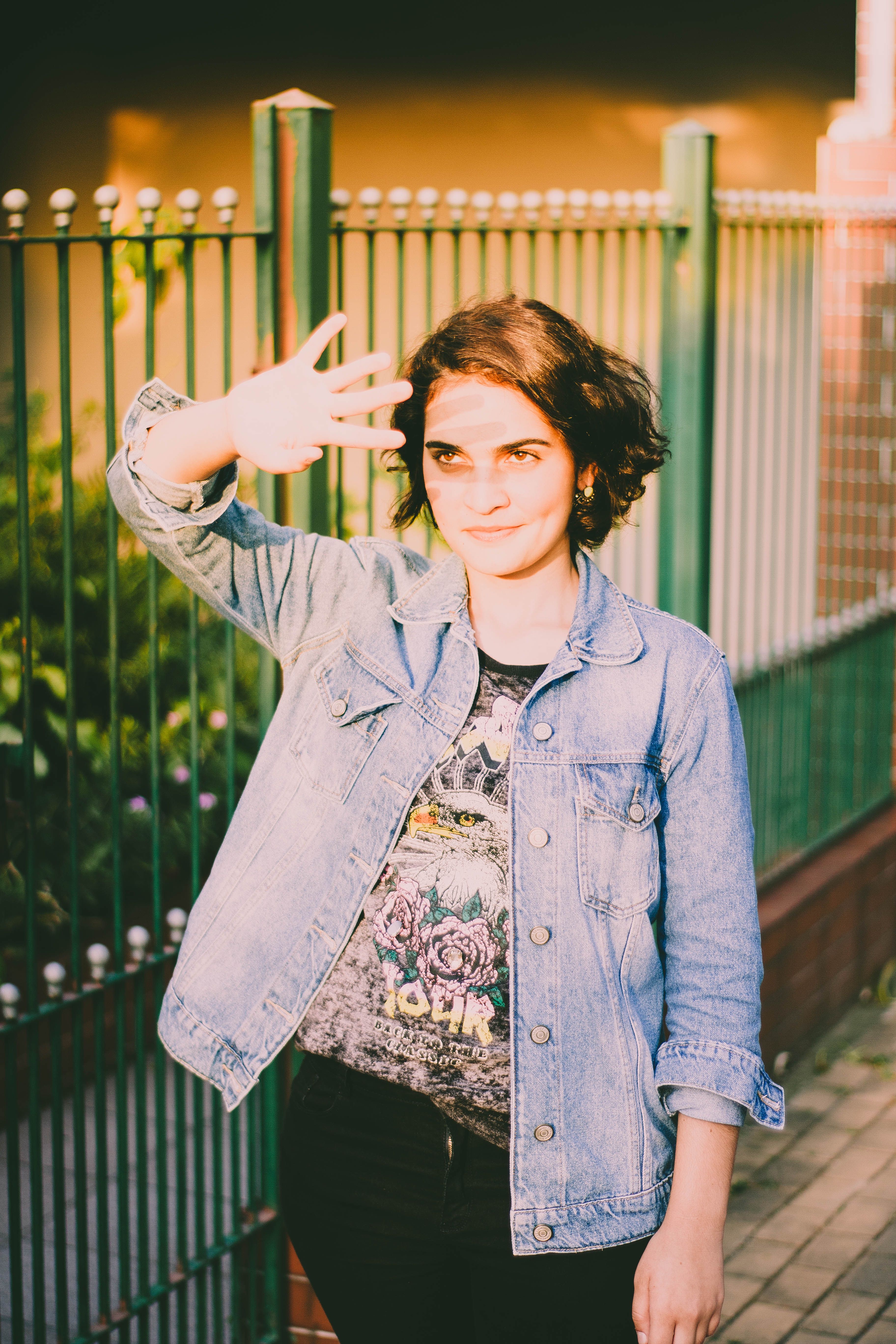 A Woman in a Denim Jacket Covering the Sunlight · Free Stock Photo