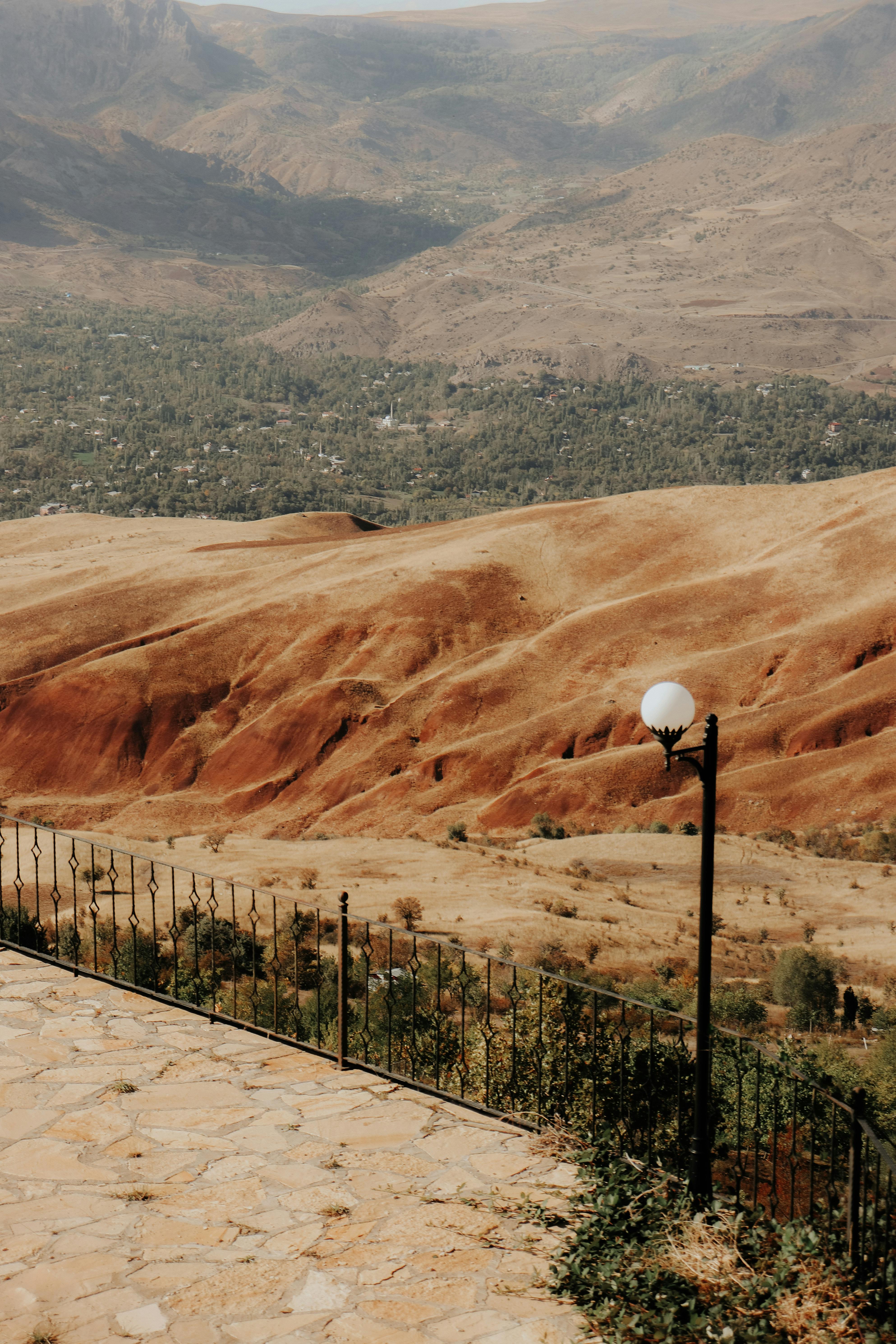 Viewing Deck near a Brown Hill · Free Stock Photo