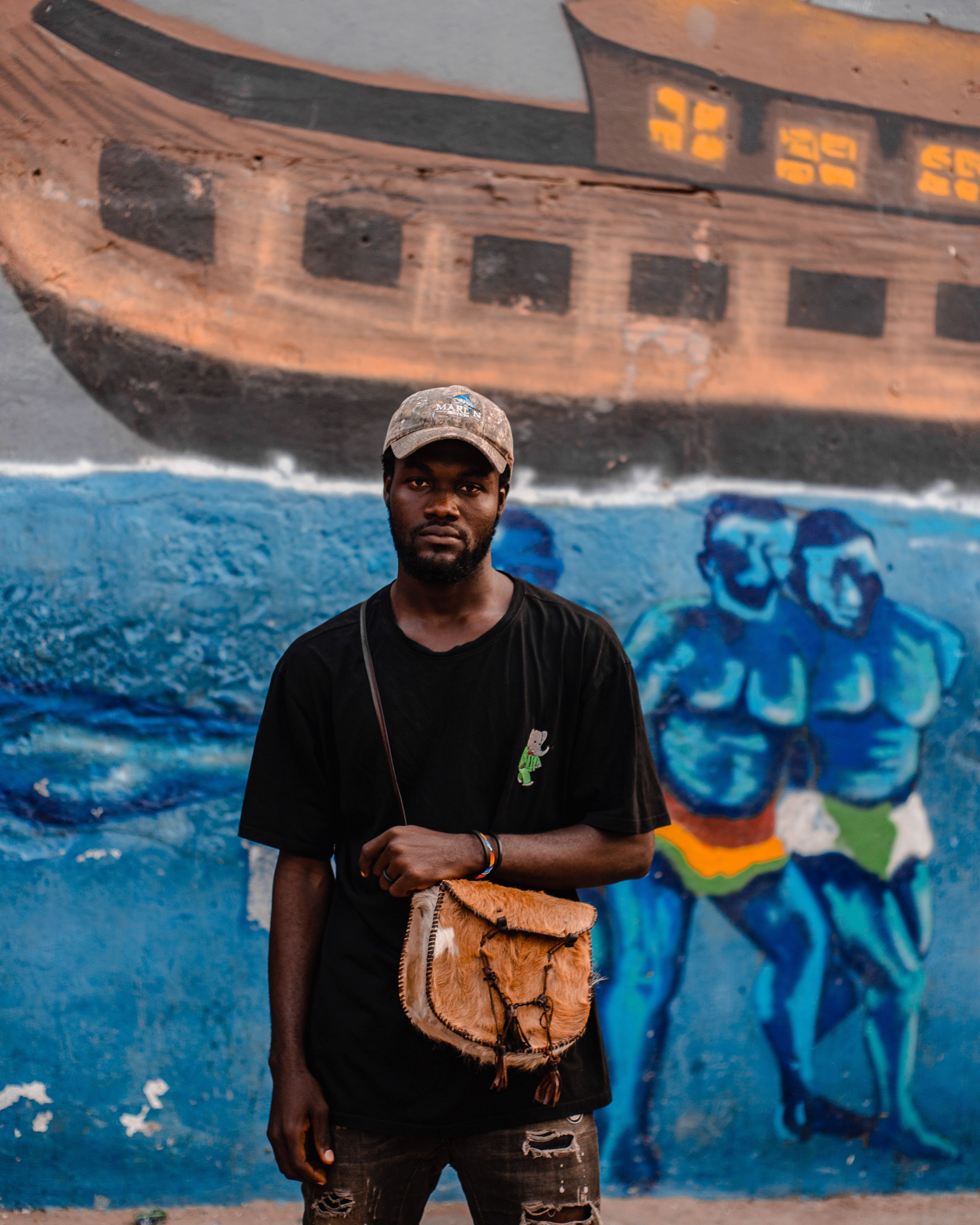 Man Posing near Wall with Mural · Free Stock Photo