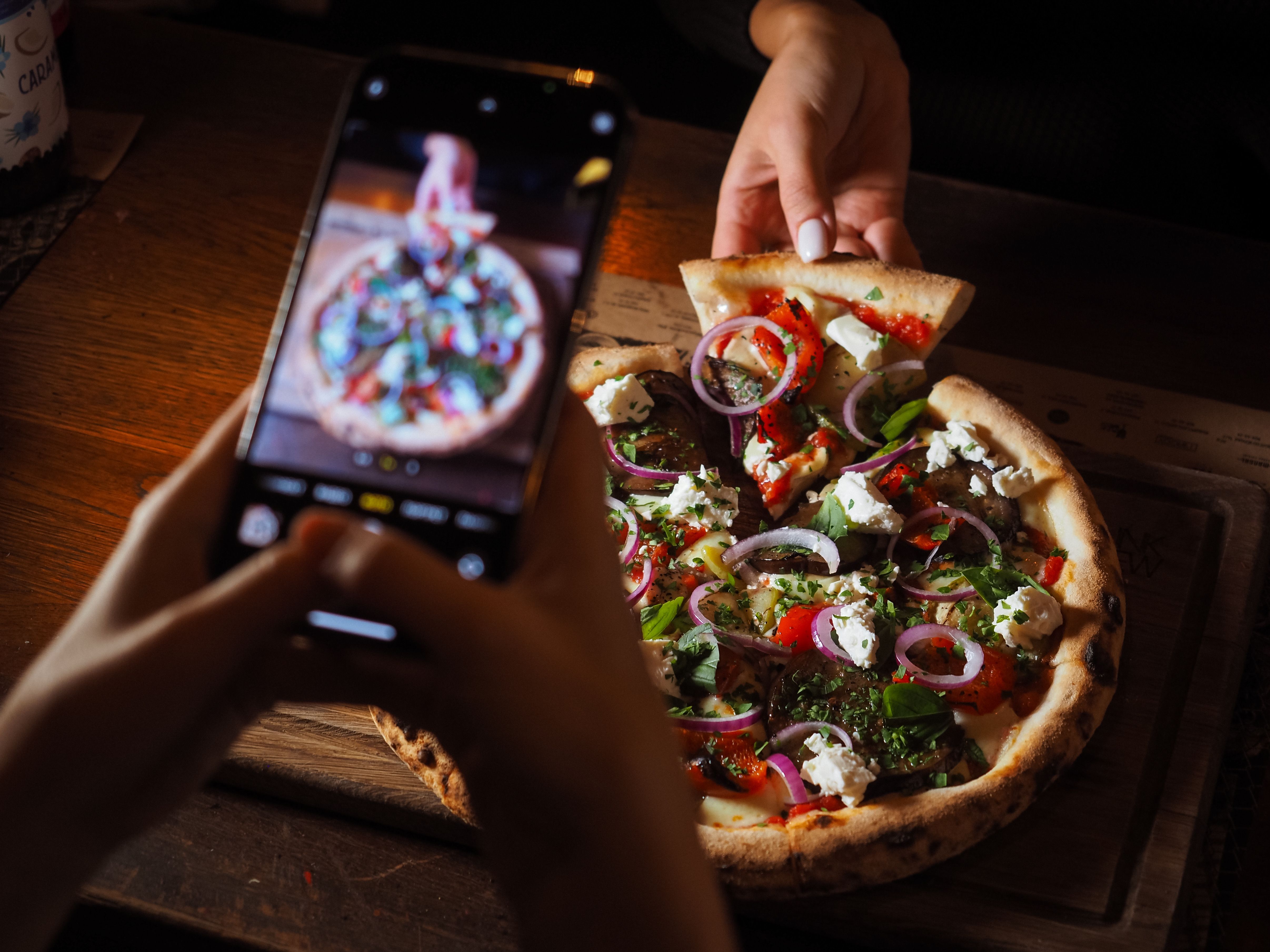 Photographing Pizza with Smartphone · Free Stock Photo