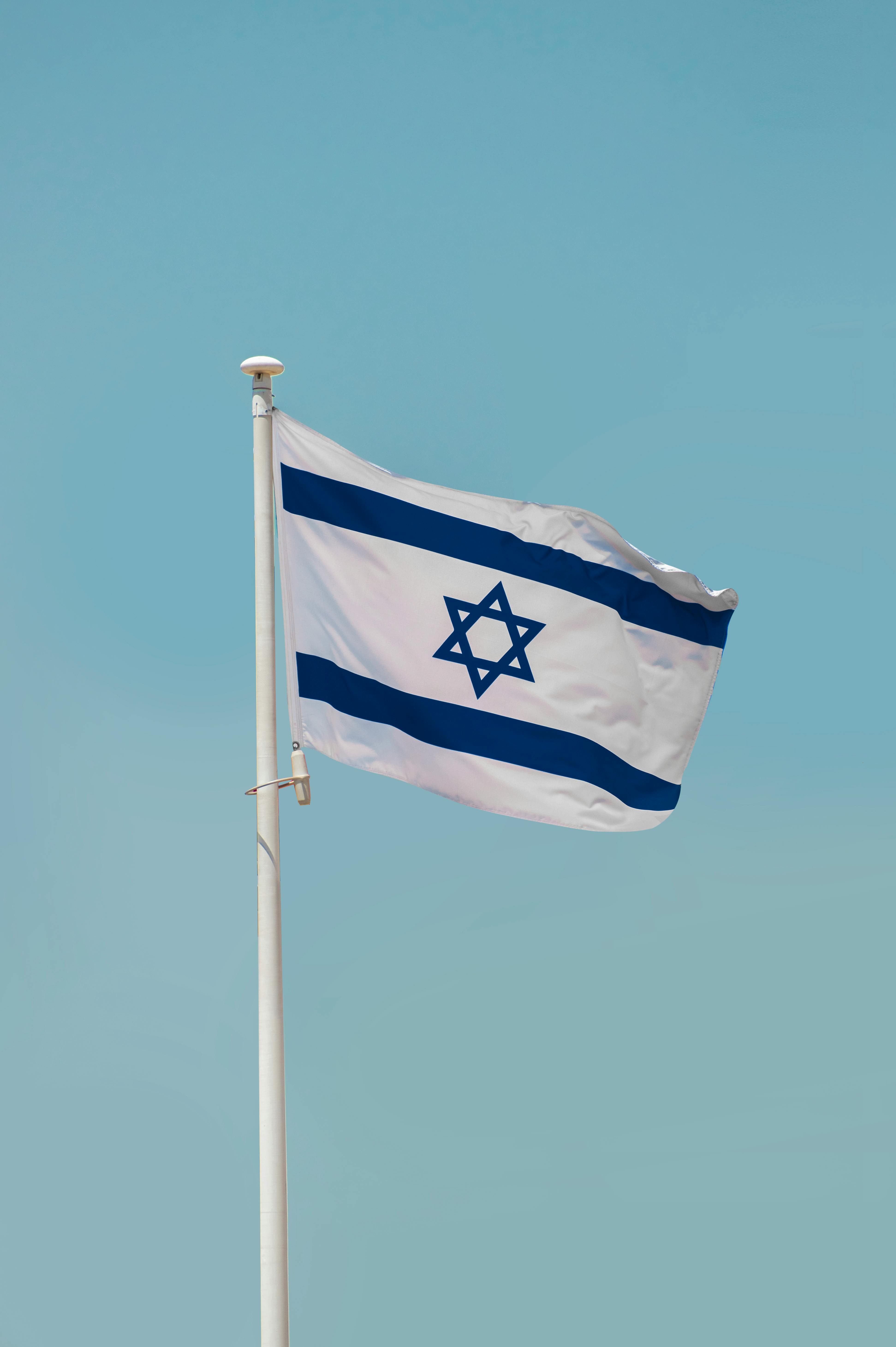 Flag of Israel on White Pole Under Blue Sky · Free Stock Photo