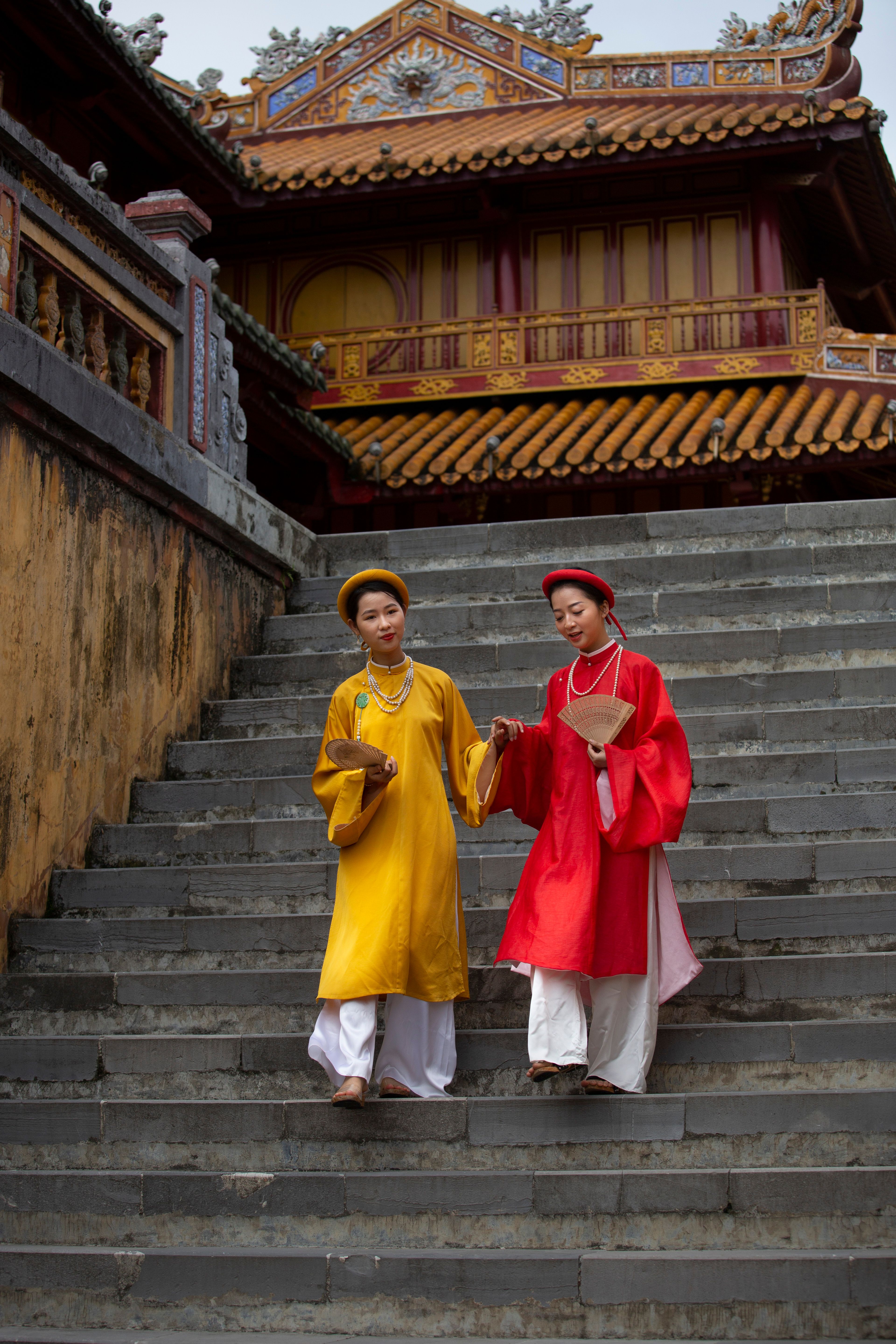 Women in Traditional Clothing Walking Down the Stairs · Free Stock Photo