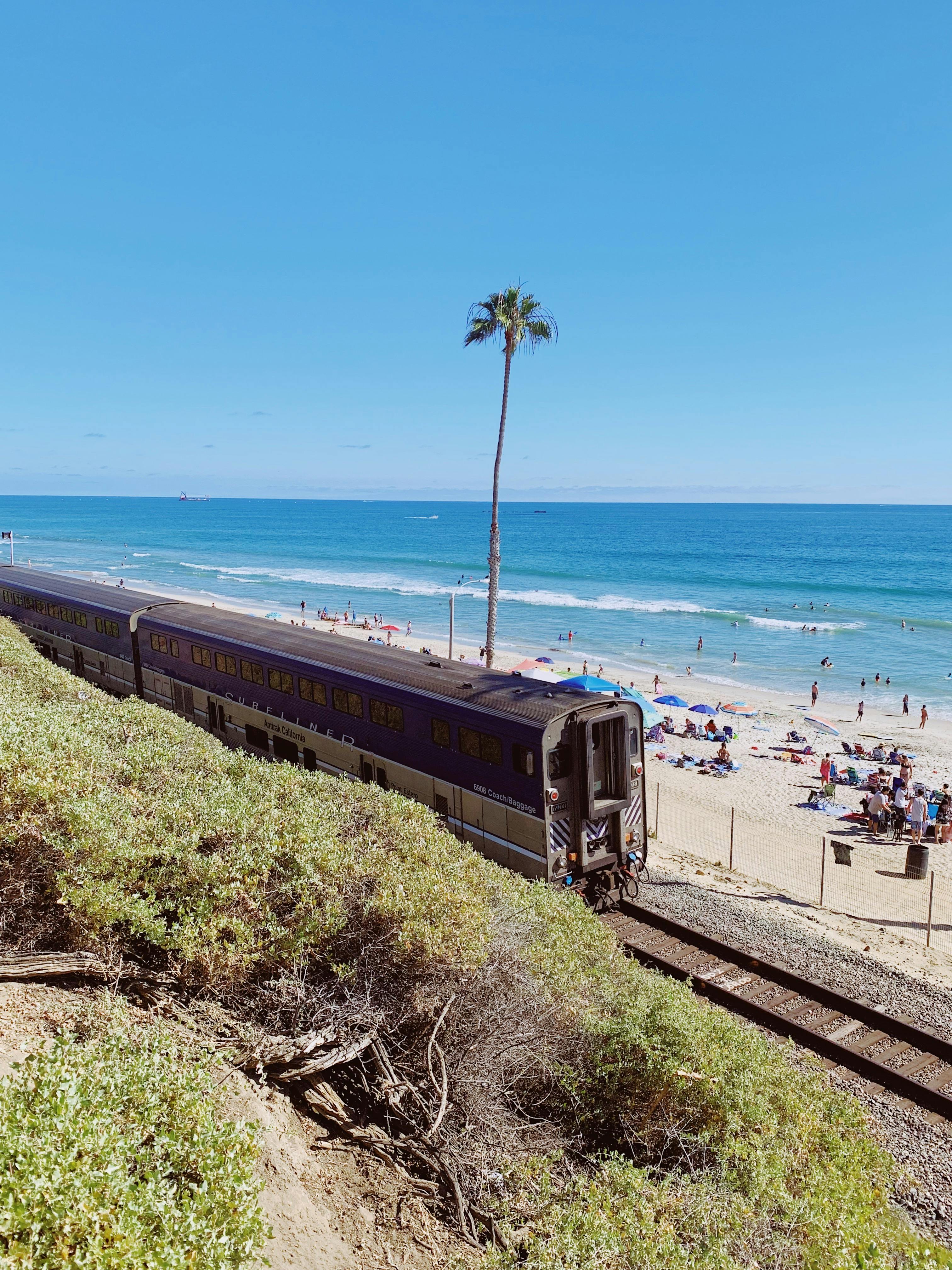 A Moving Train on Track Beside the Beach · Free Stock Photo