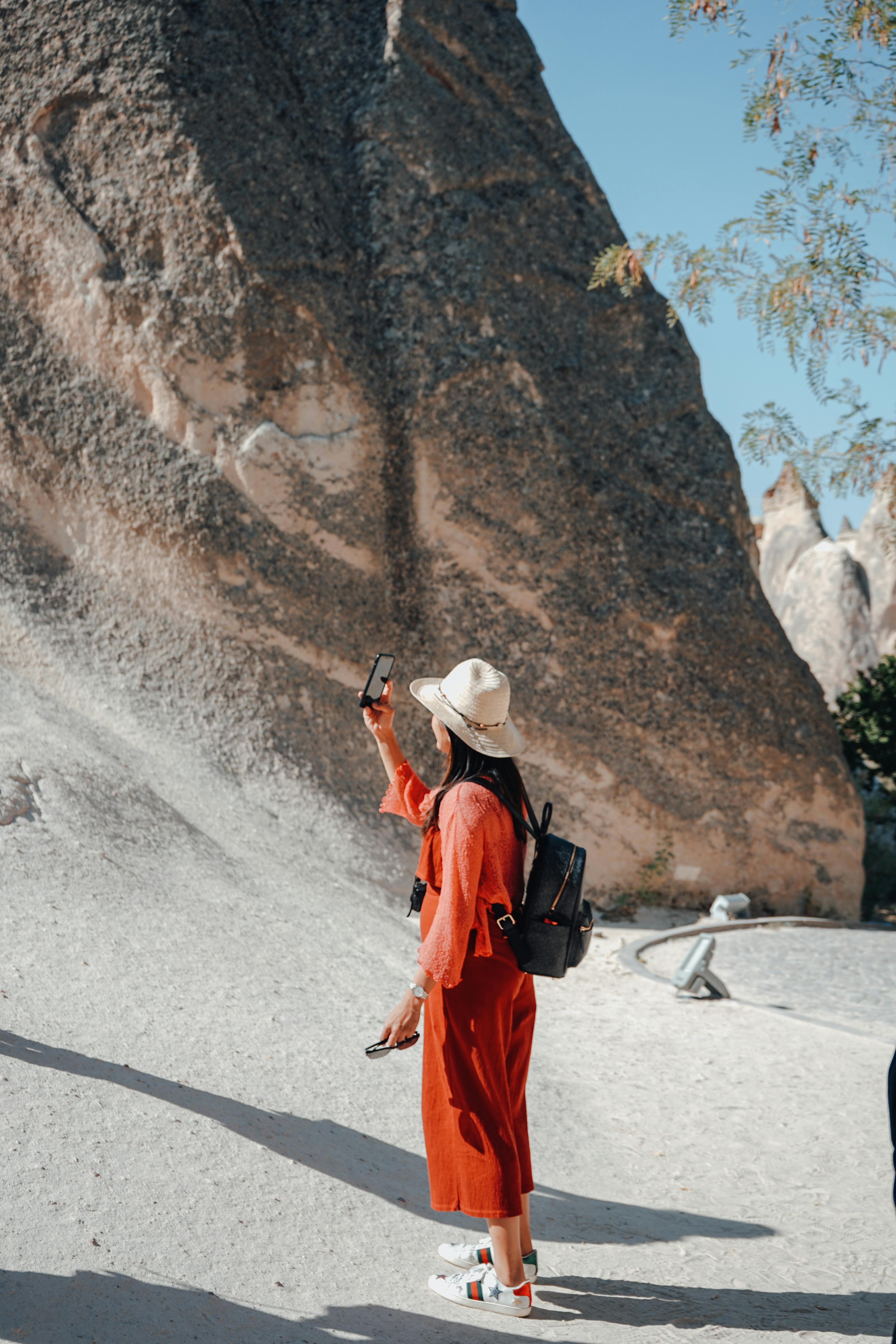 Tourist Photographing Rock Formation · Free Stock Photo