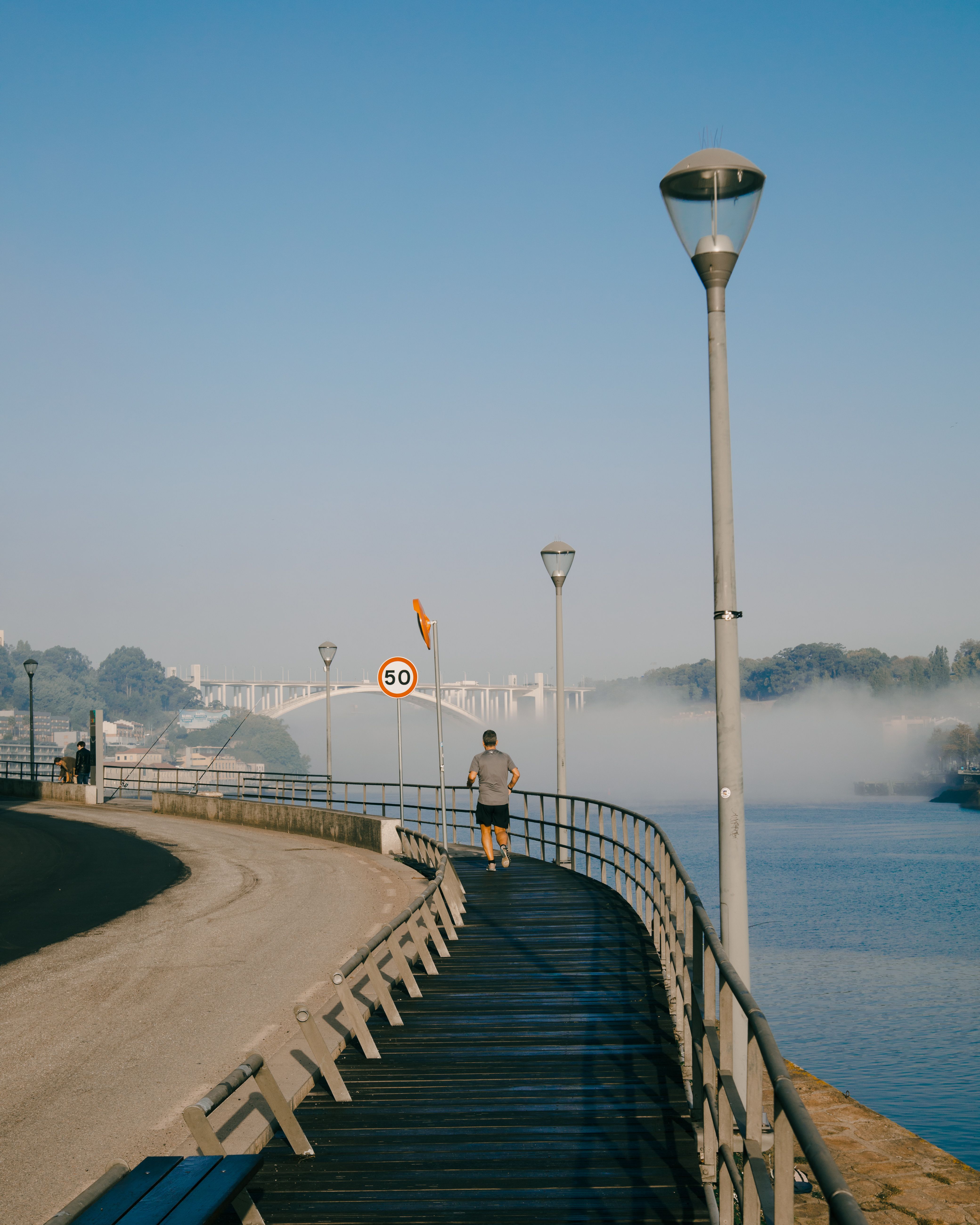 Silhouette of Man Running on Boardwalk on Sunset · Free Stock Photo