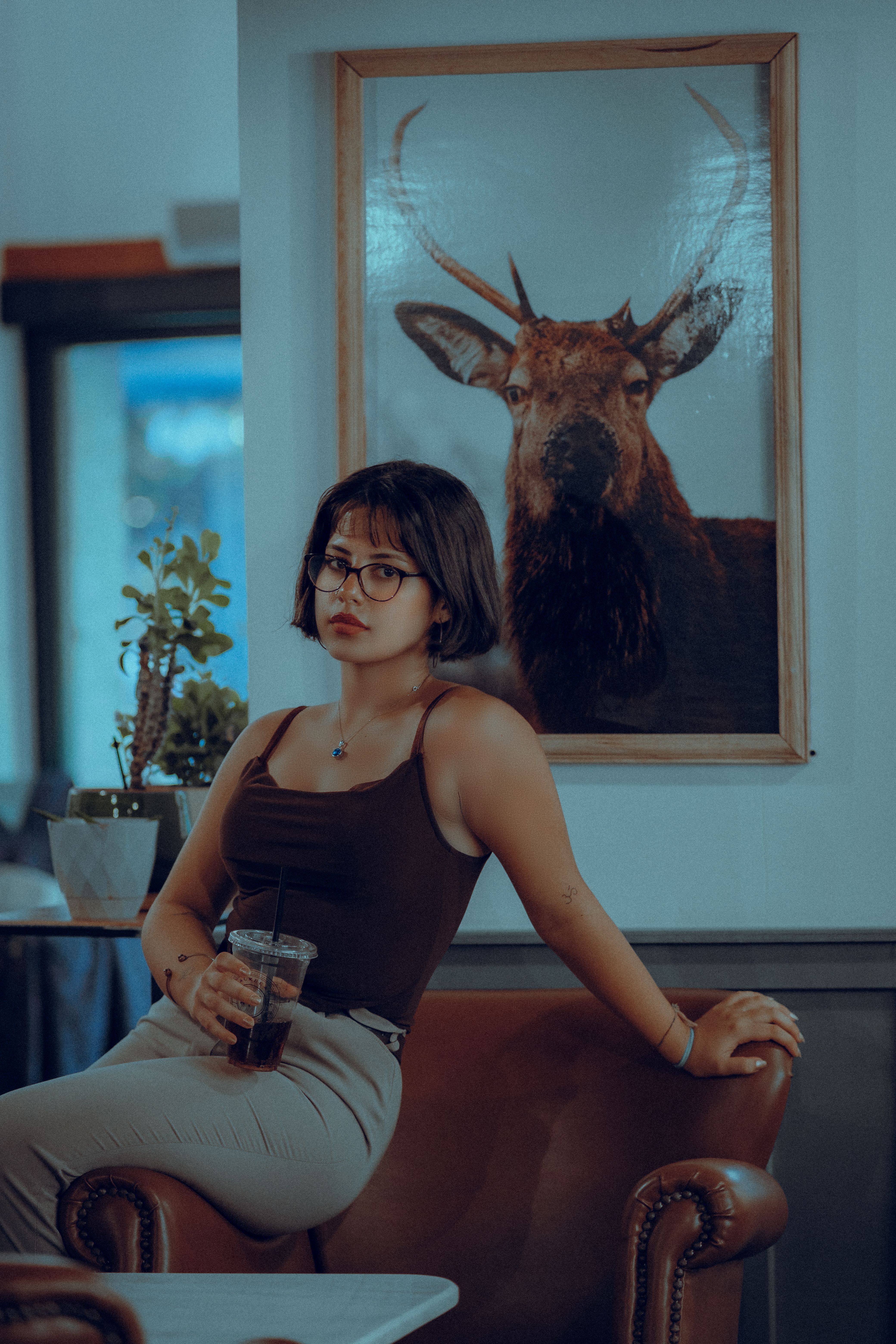 A Woman Sitting on the Arm of a Chair · Free Stock Photo
