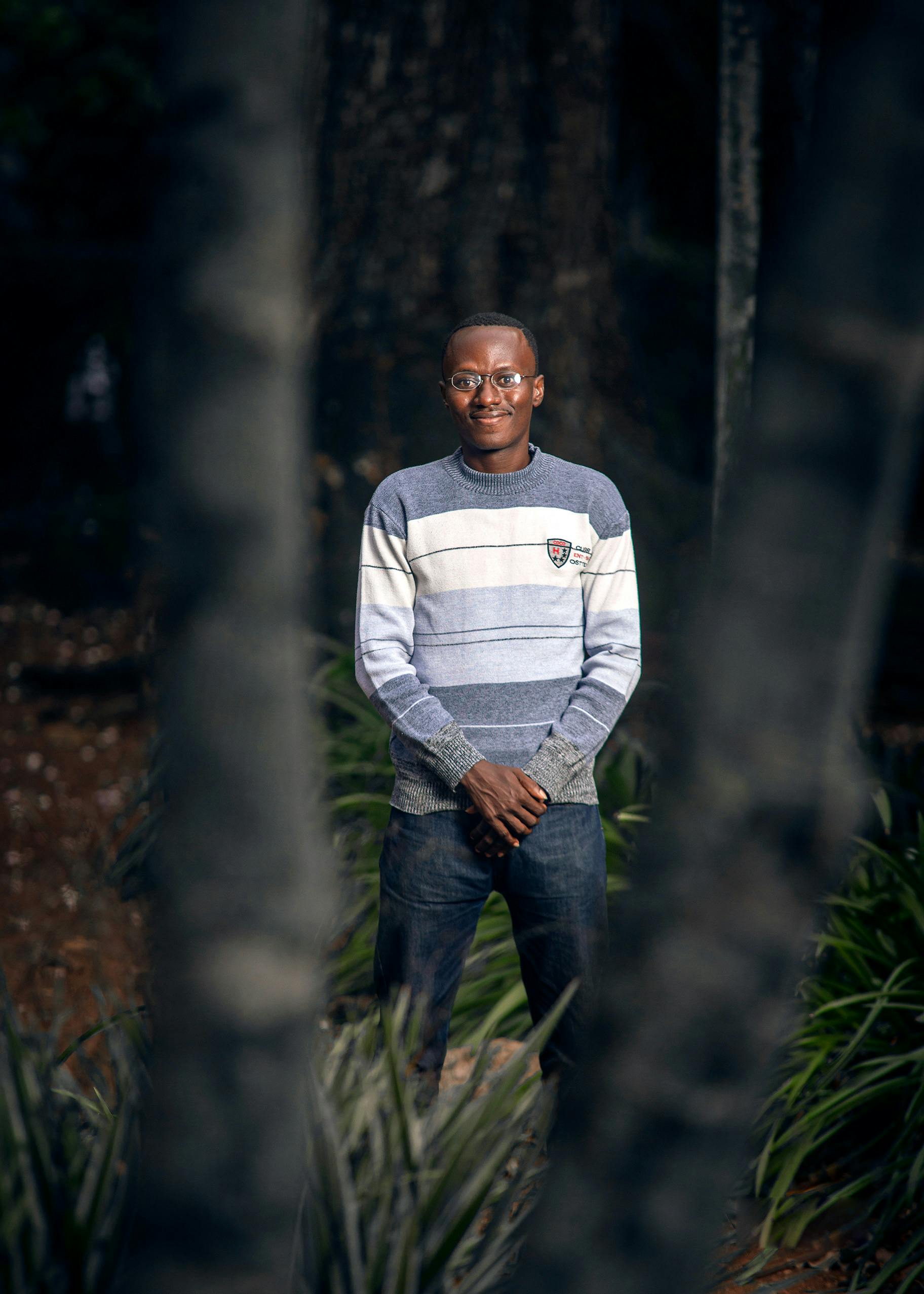 Man Standing between Trees in Forest · Free Stock Photo