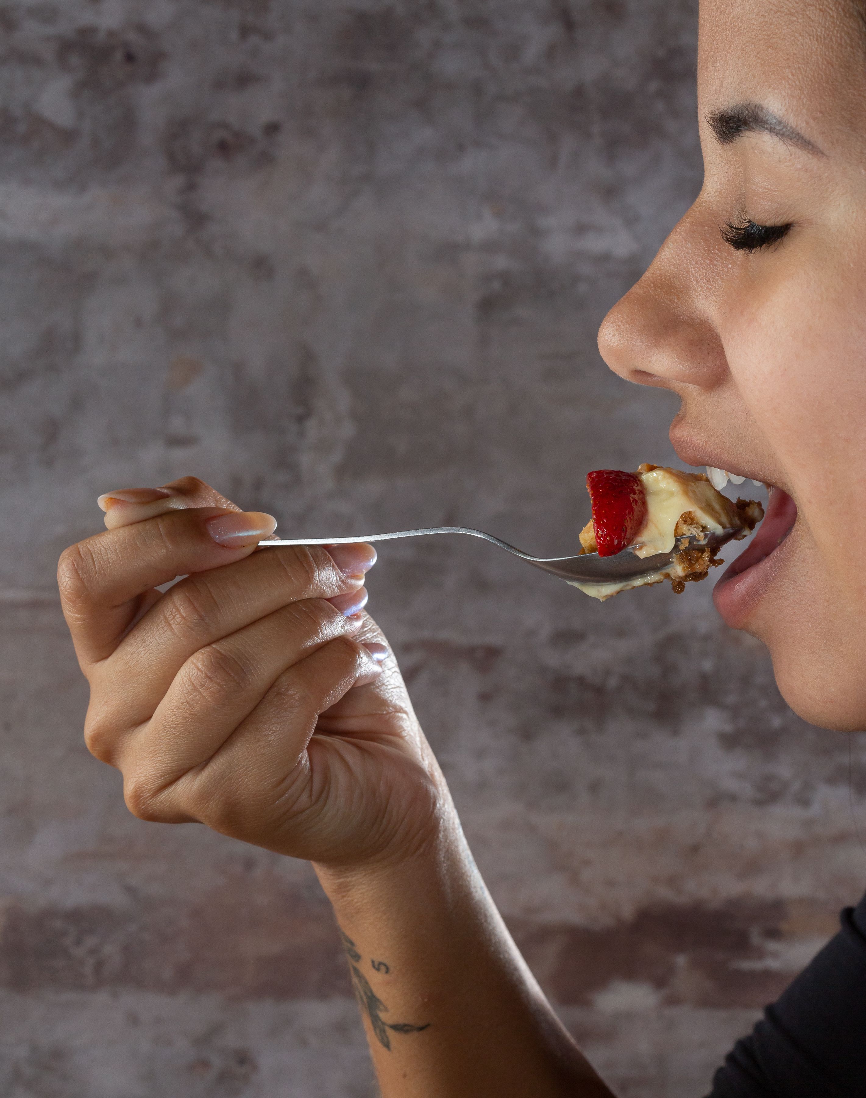 Woman in Red Coat Eating · Free Stock Photo