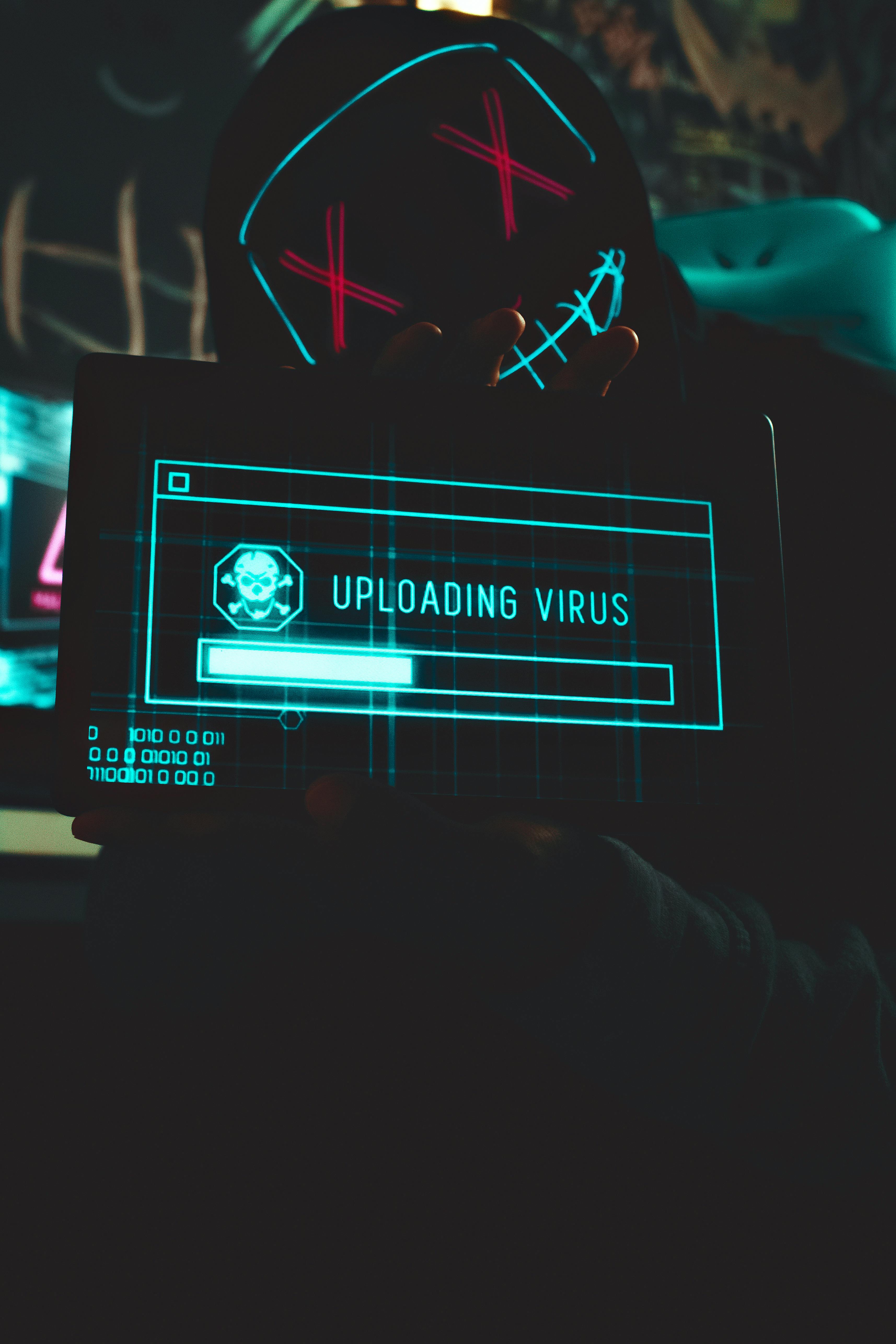 Hacker Holding Screen with Virus · Free Stock Photo