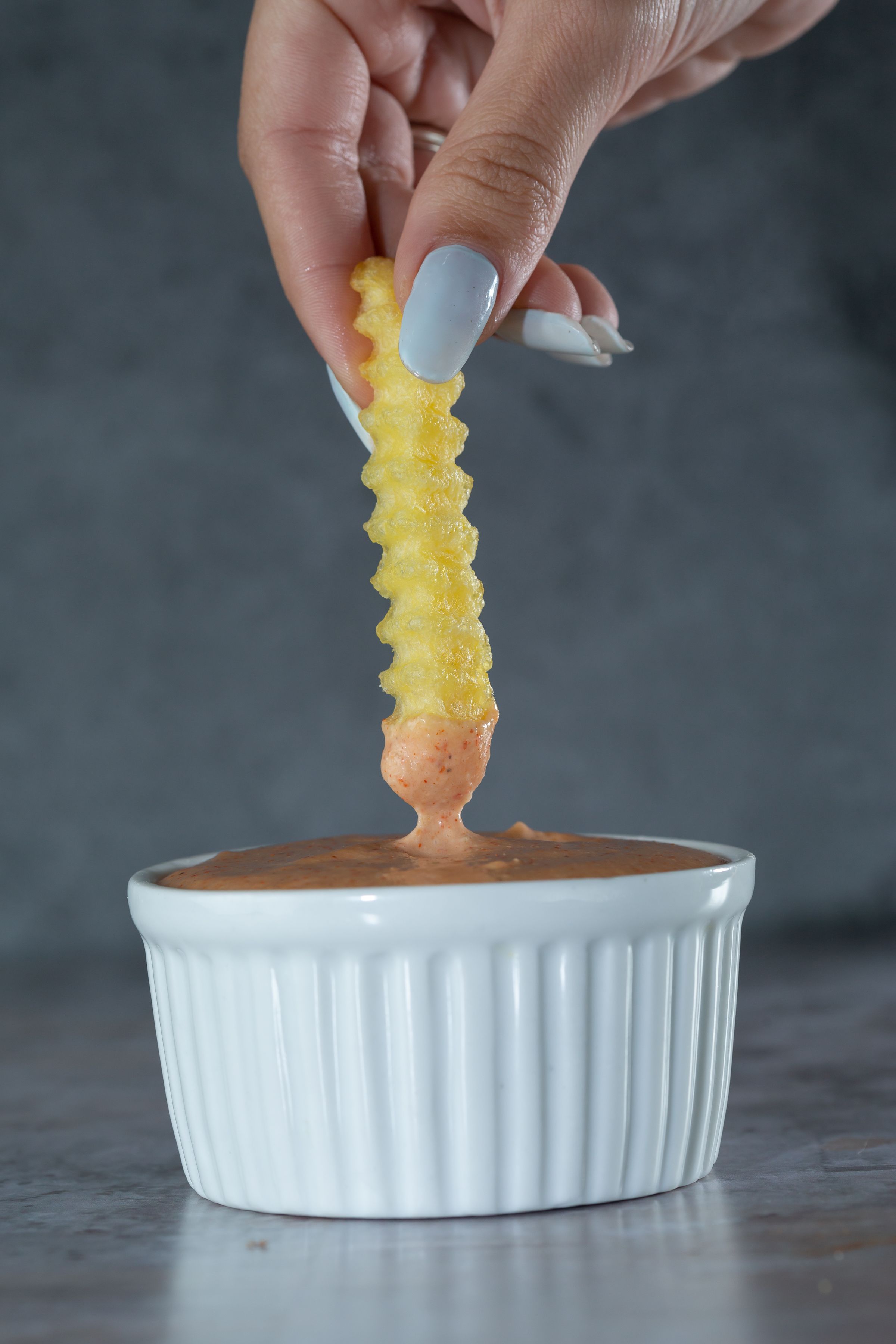Woman Hand Dipping Fries in Sauce · Free Stock Photo
