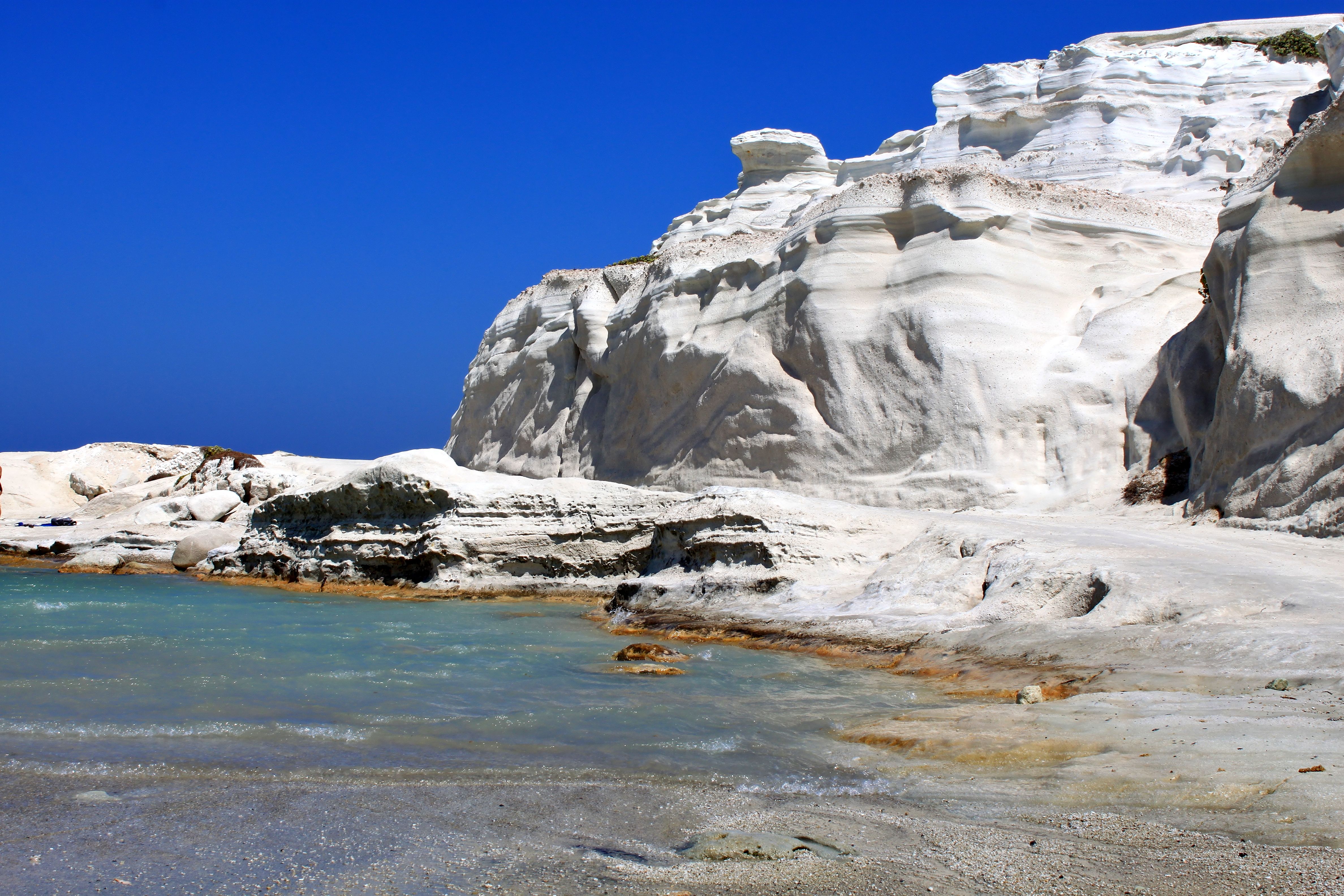 Lagoon and Beach Surrounded by Rock Formation · Free Stock Photo