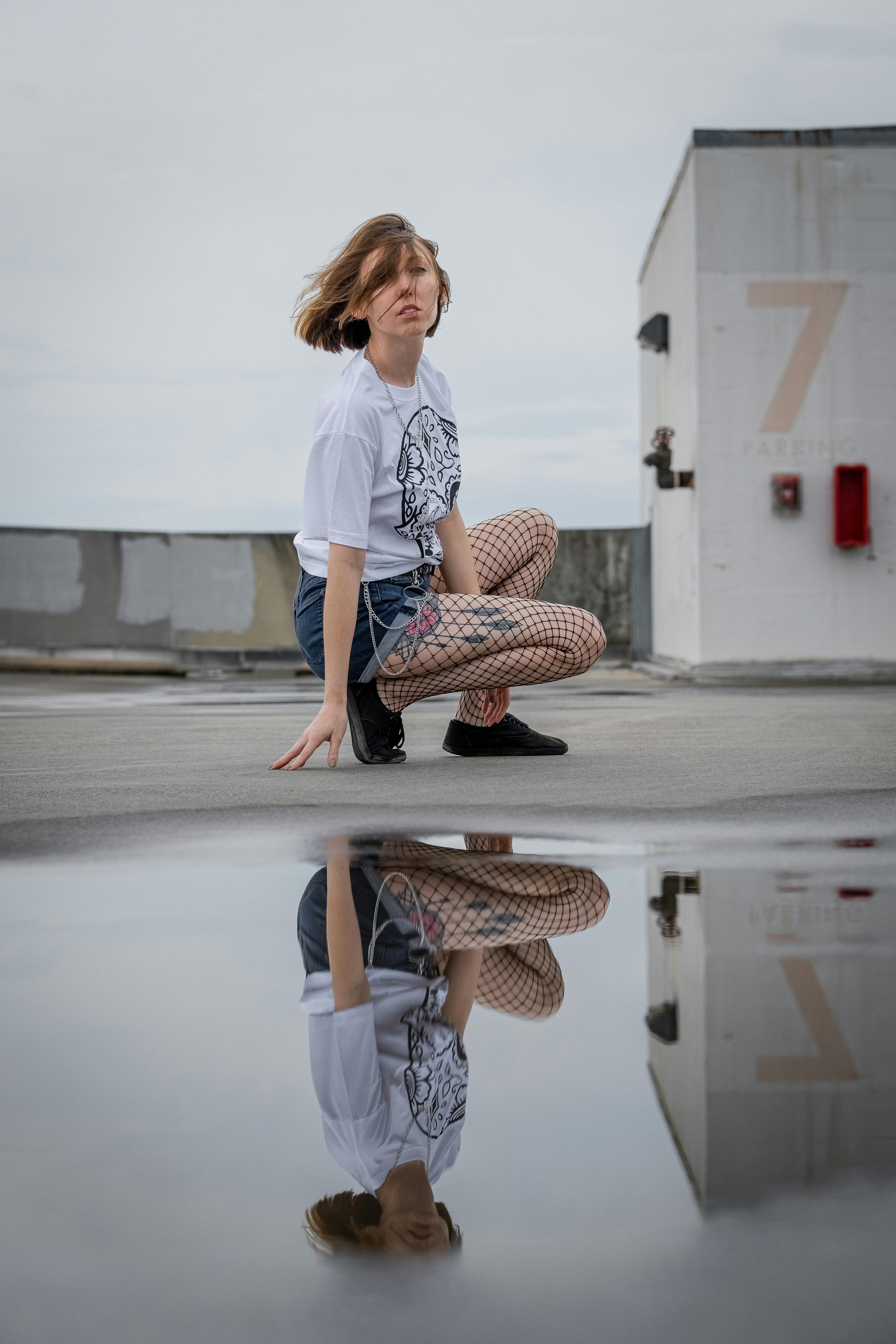 Woman and Her Reflection in Water on the Ground · Free Stock Photo