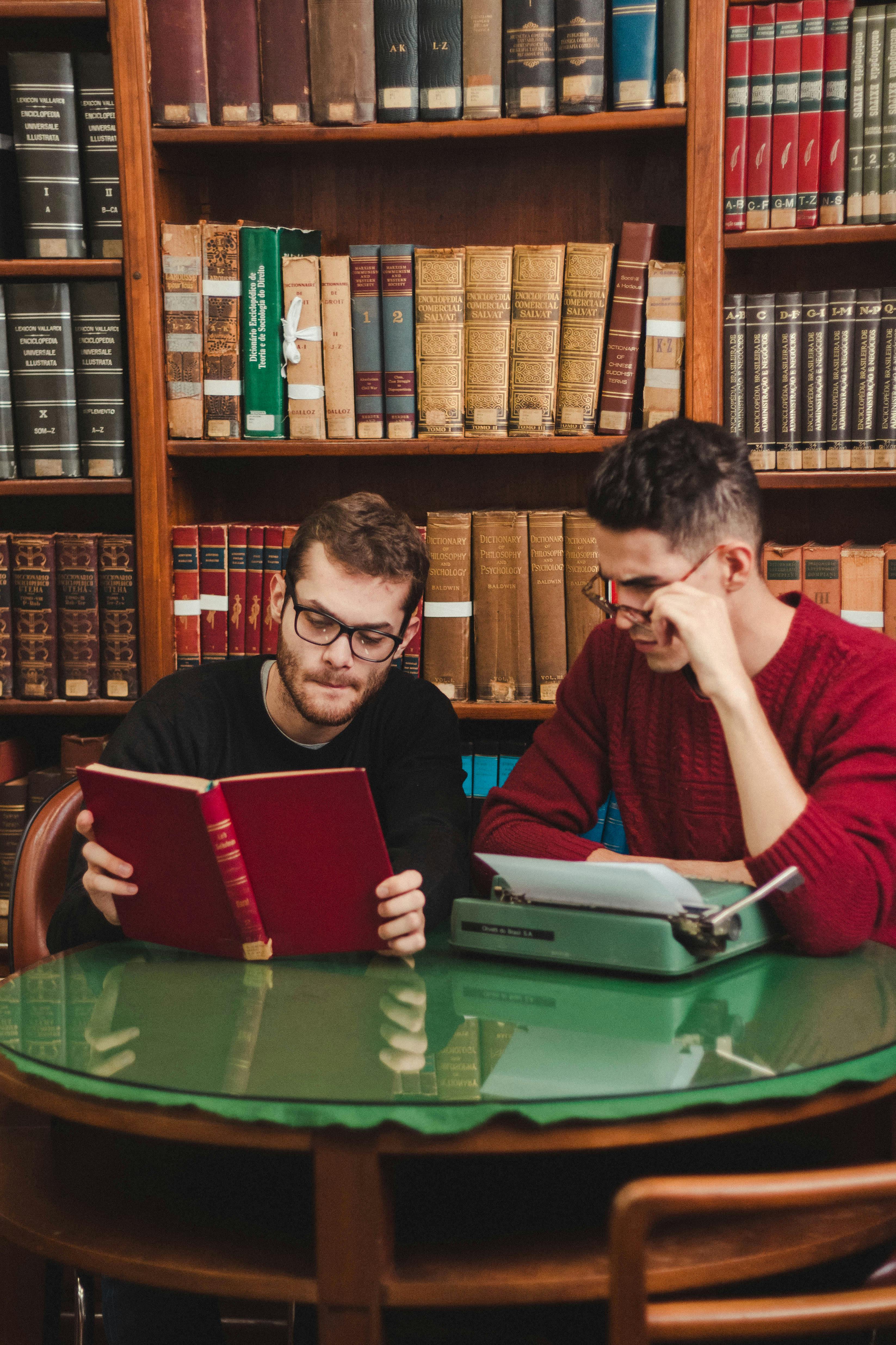 Men in the Library Reading Book Together · Free Stock Photo
